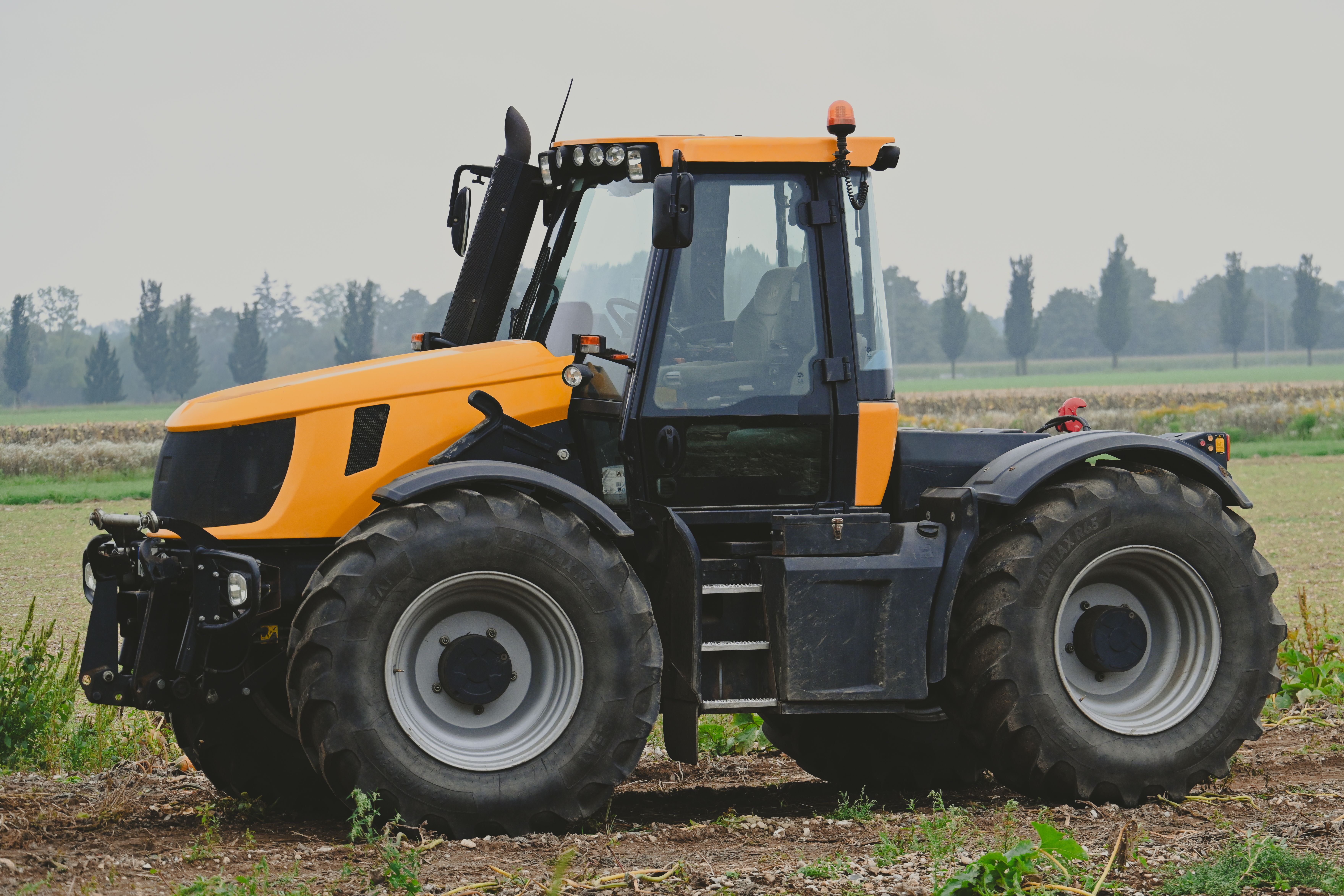 Modern Tractor in a Rural Farmland Scene · Free Stock Photo