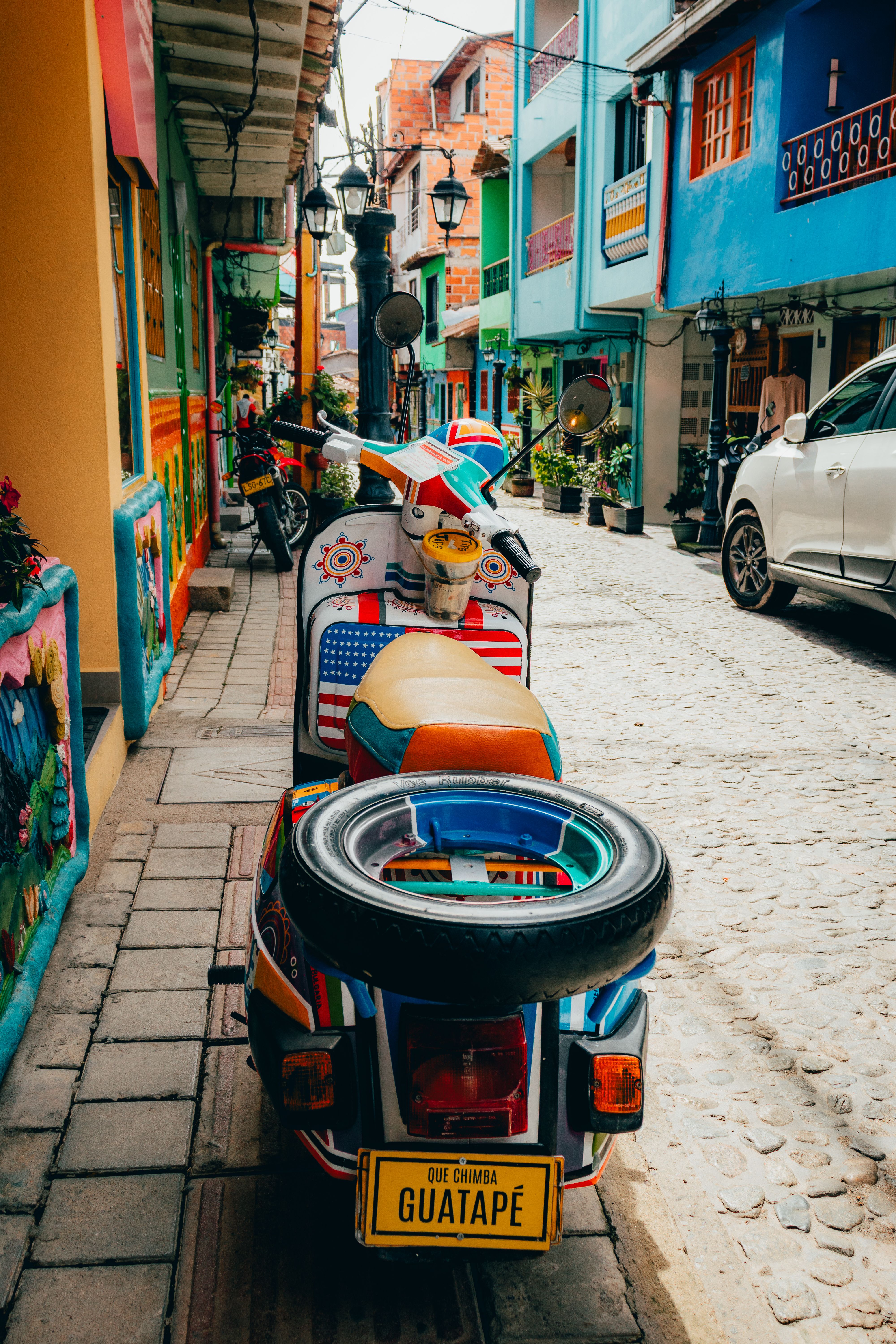 Colorful Scooter in Vibrant Guatapé Street · Free Stock Photo
