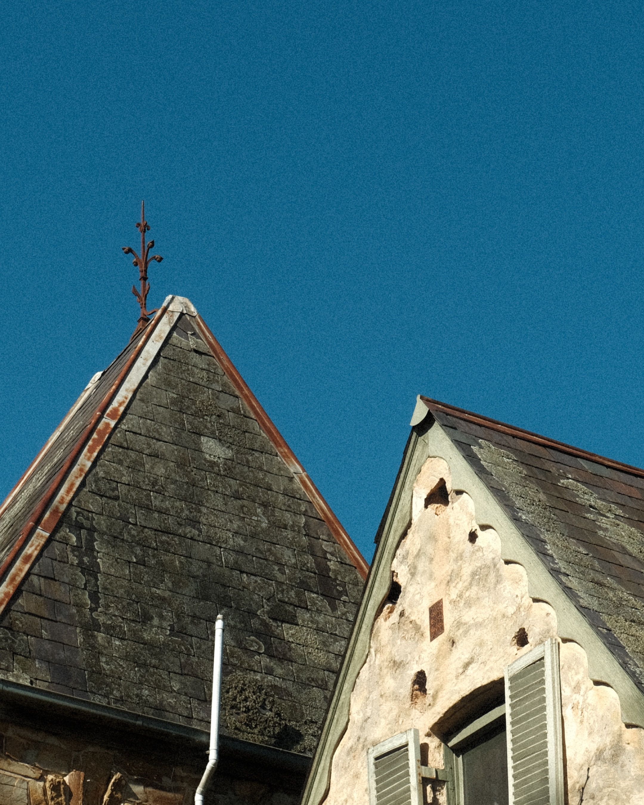 Antique Slate Roof Against Clear Blue Sky · Free Stock Photo