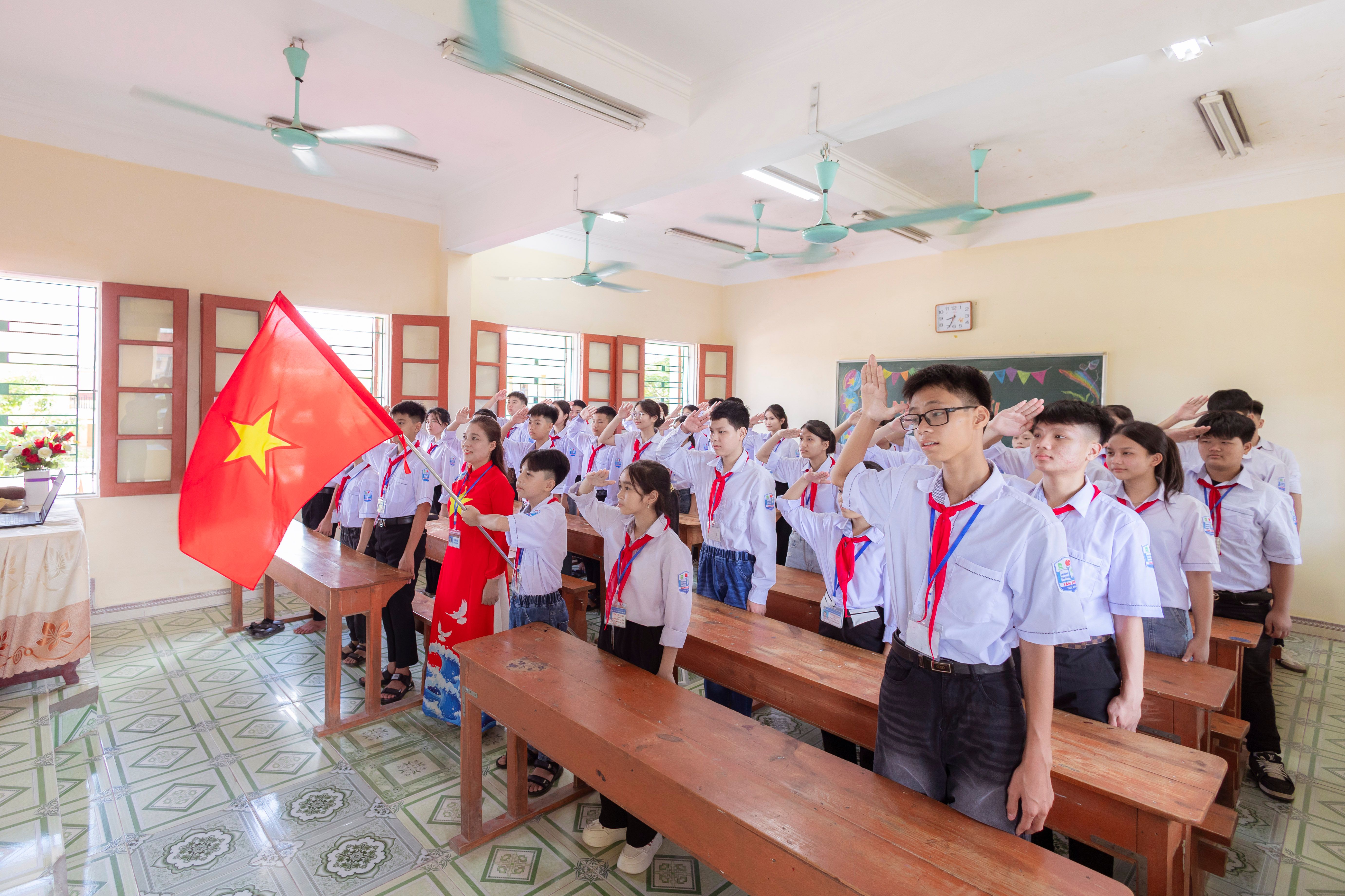 Vietnamese Students Saluting National Flag in Classroom · Free Stock Photo