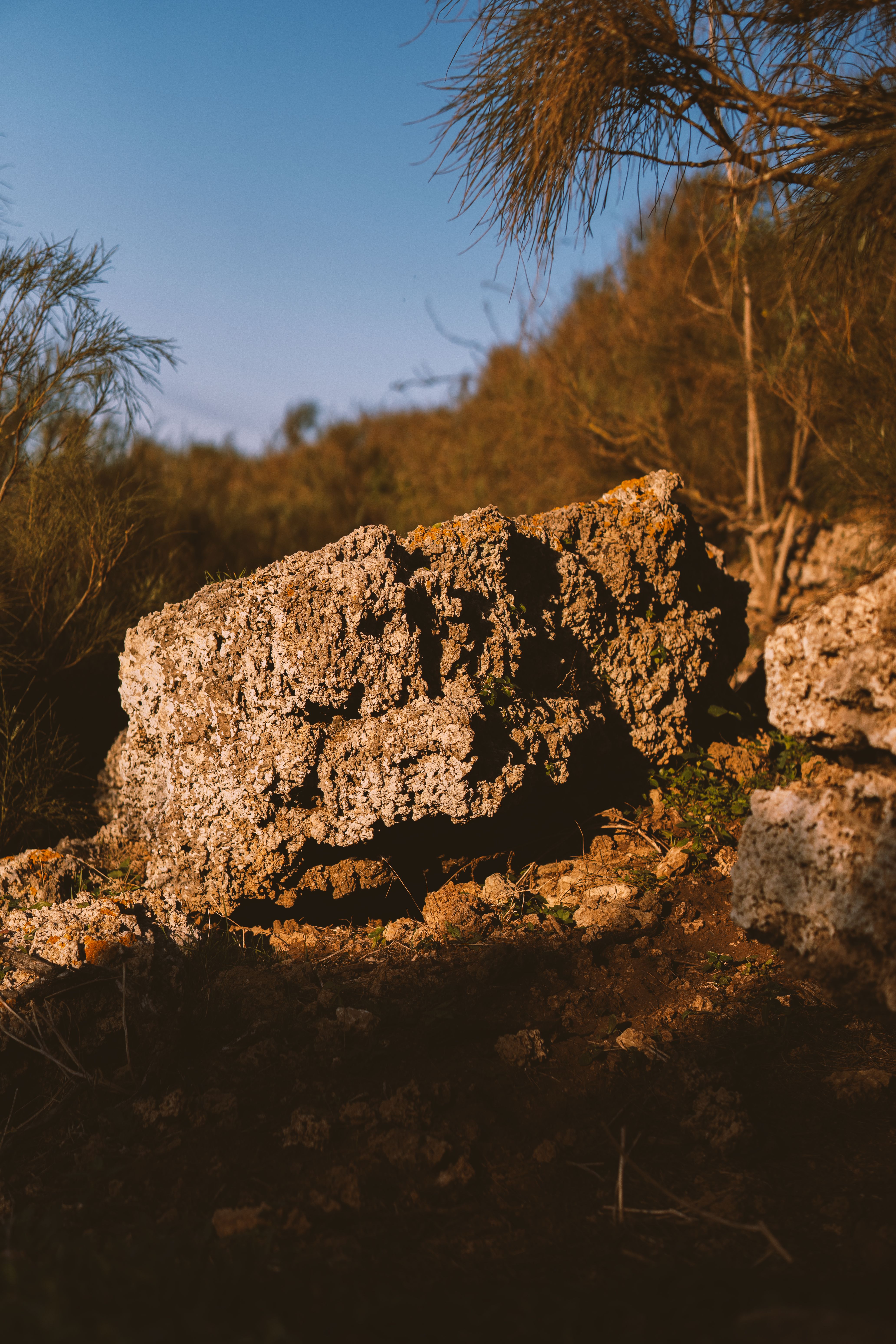 Sunlit Rock Formation in Natural Landscape · Free Stock Photo