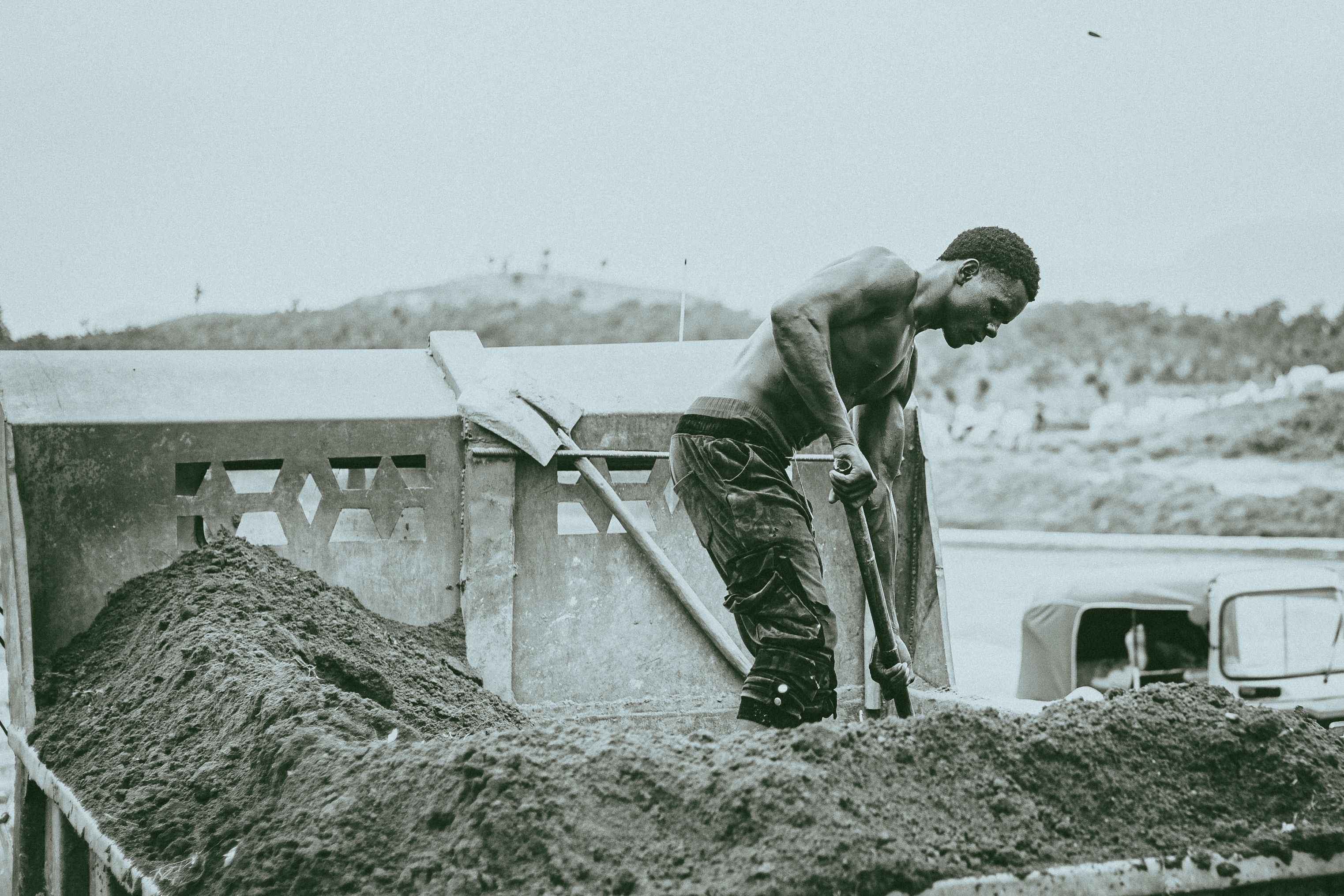 Man Working with Shovel on Construction Site · Free Stock Photo