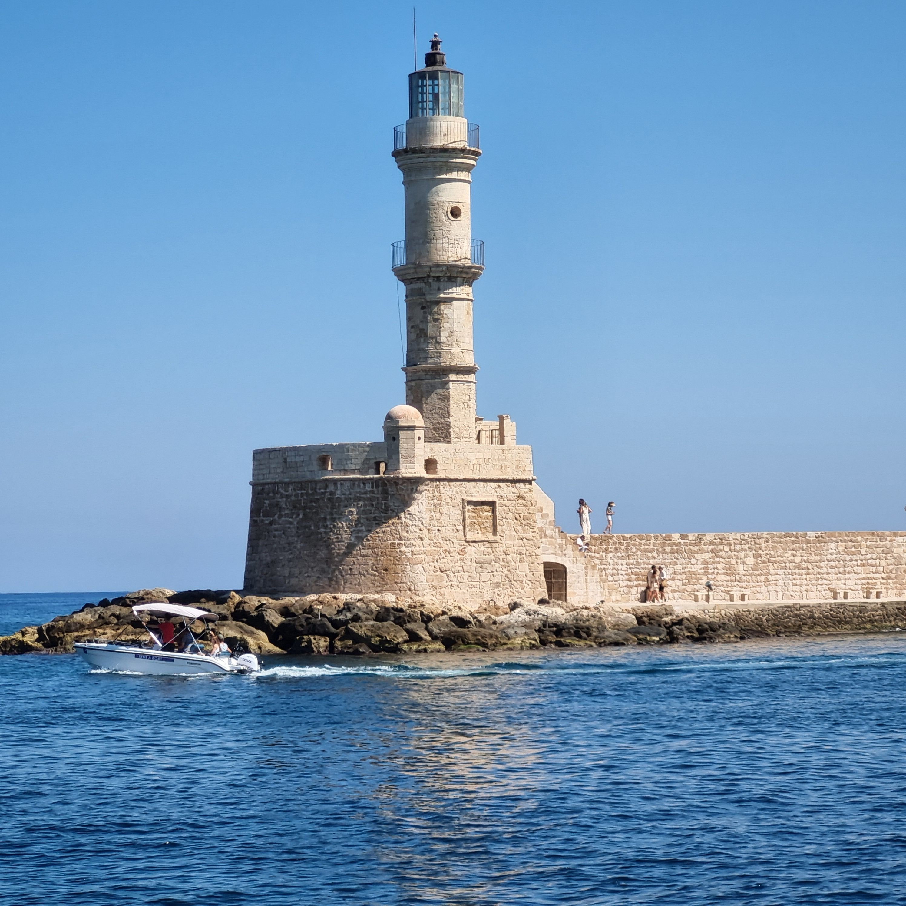 Chania Lighthouse with Boat in Summer Scene · Free Stock Photo