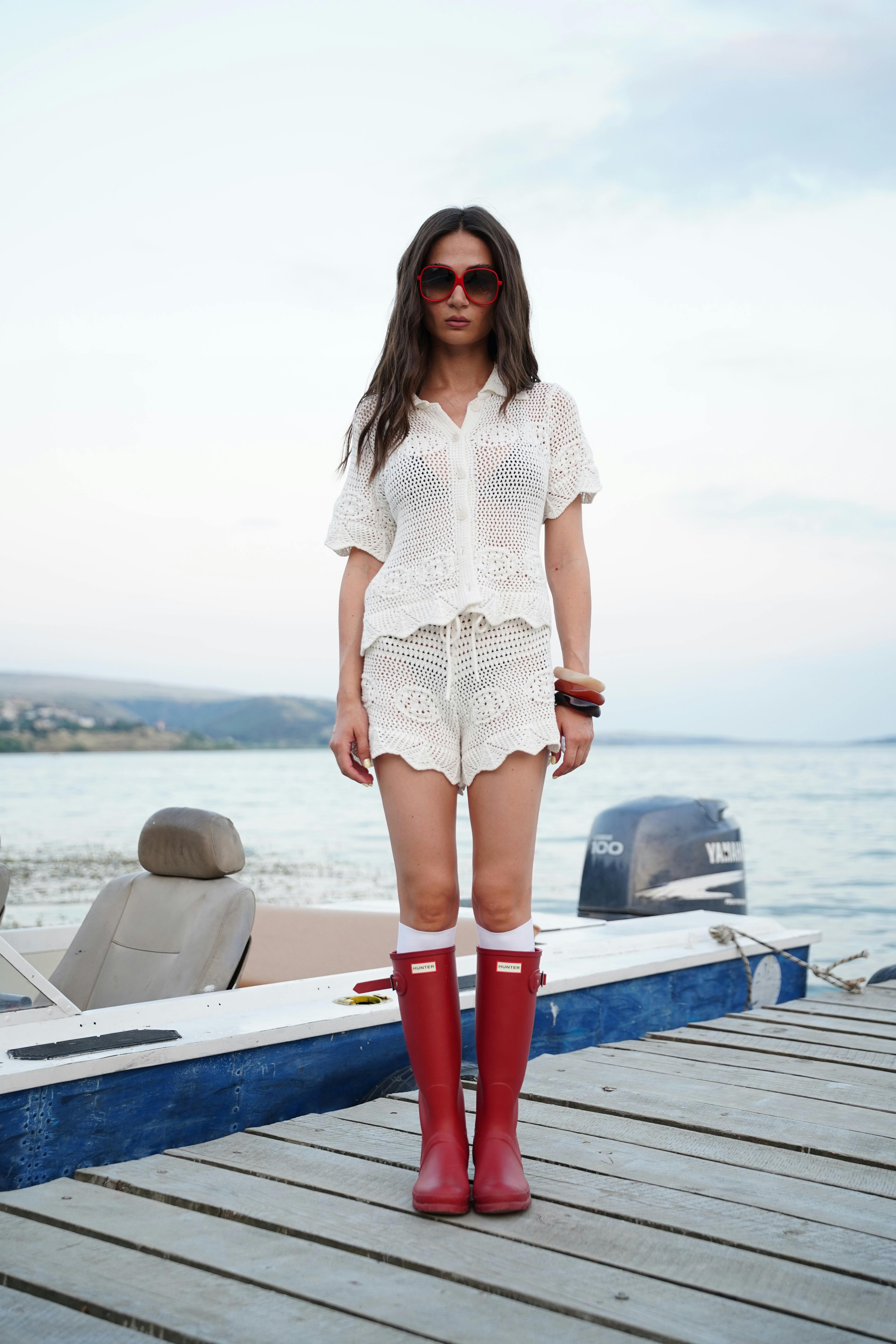 Stylish Woman in Red Boots by the Seaside Dock · Free Stock Photo