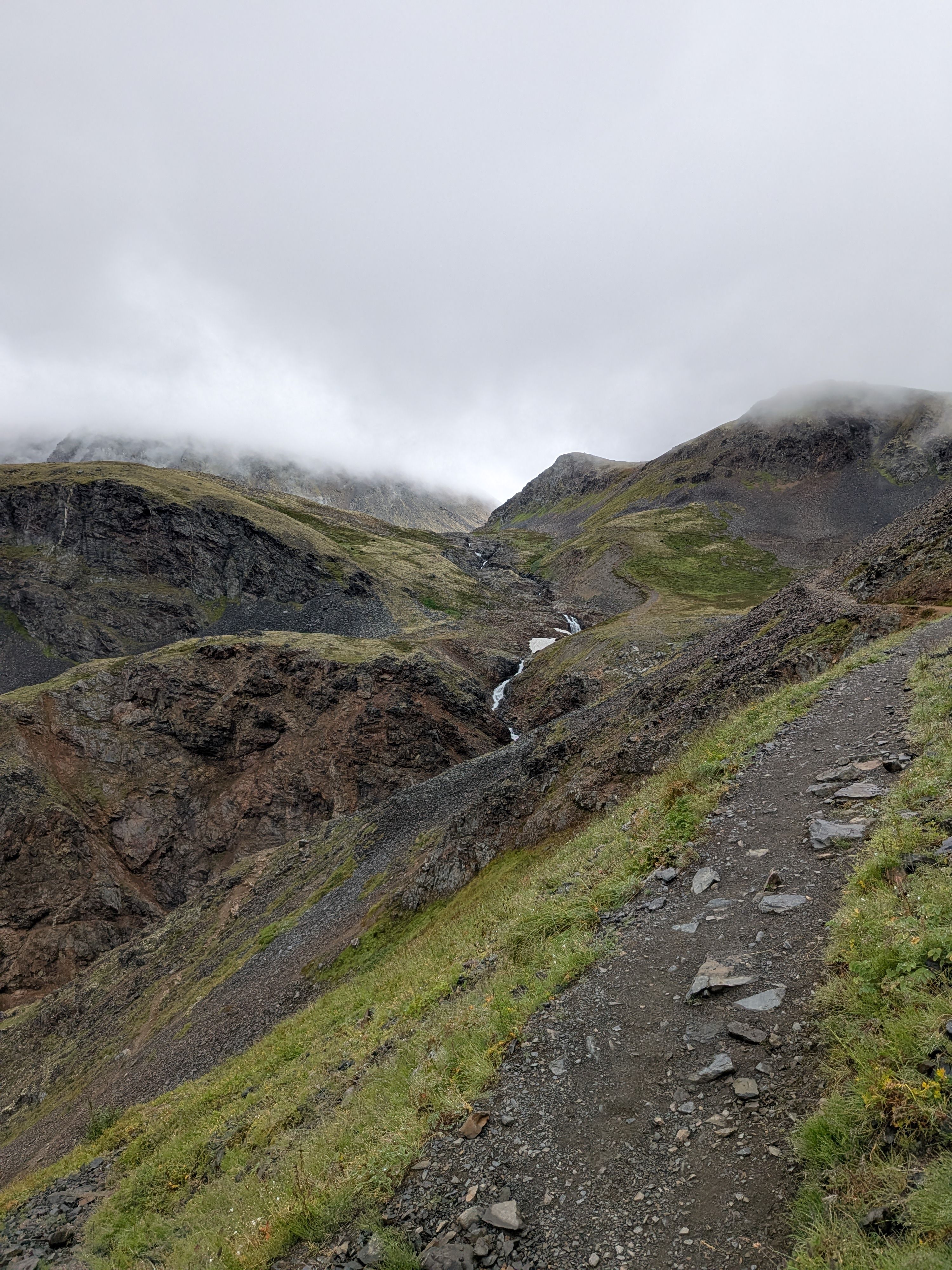 Hiker Ascending Misty Mountain Trail · Free Stock Photo