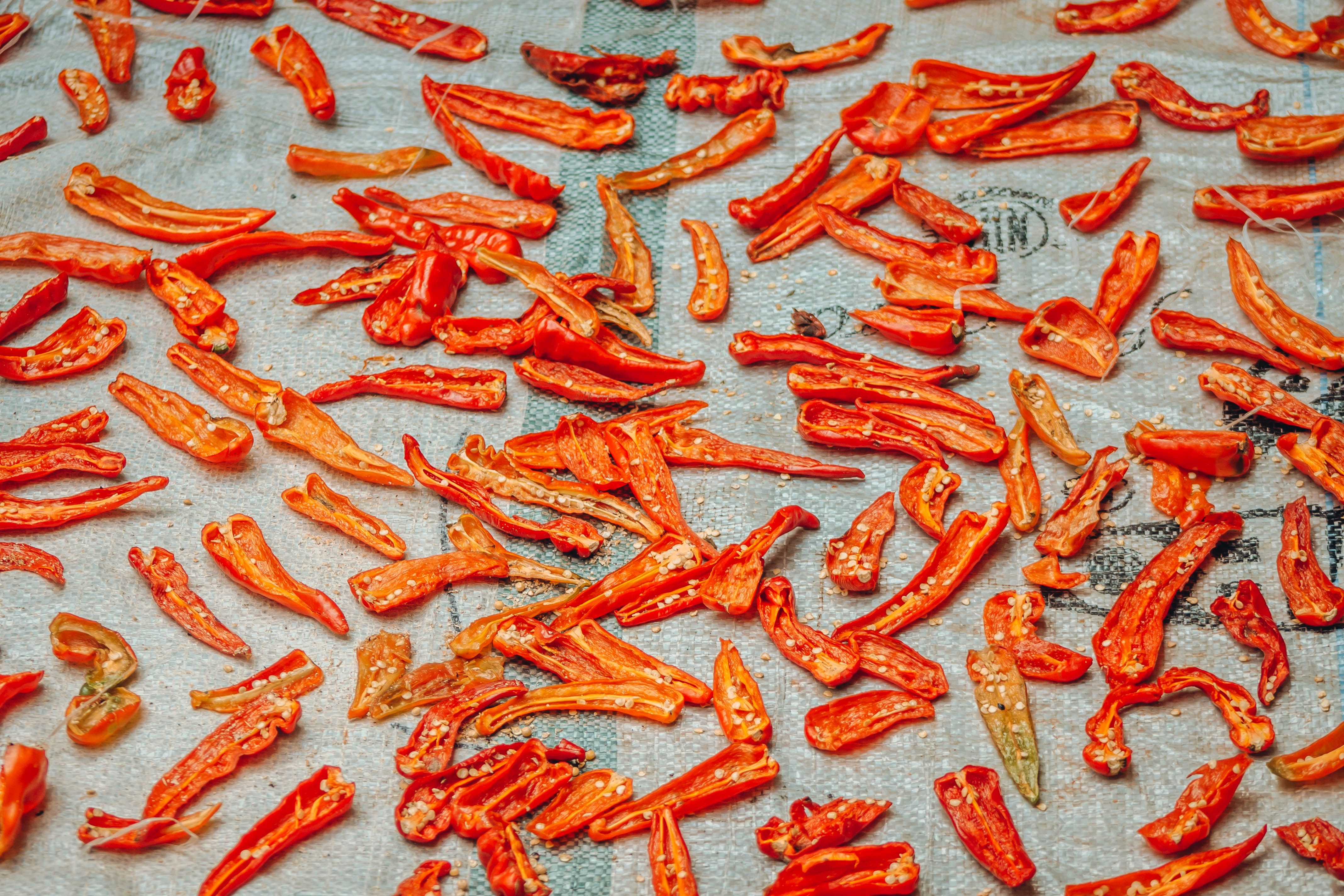 Sun-dried Red Chili Peppers on Fabric Surface · Free Stock Photo