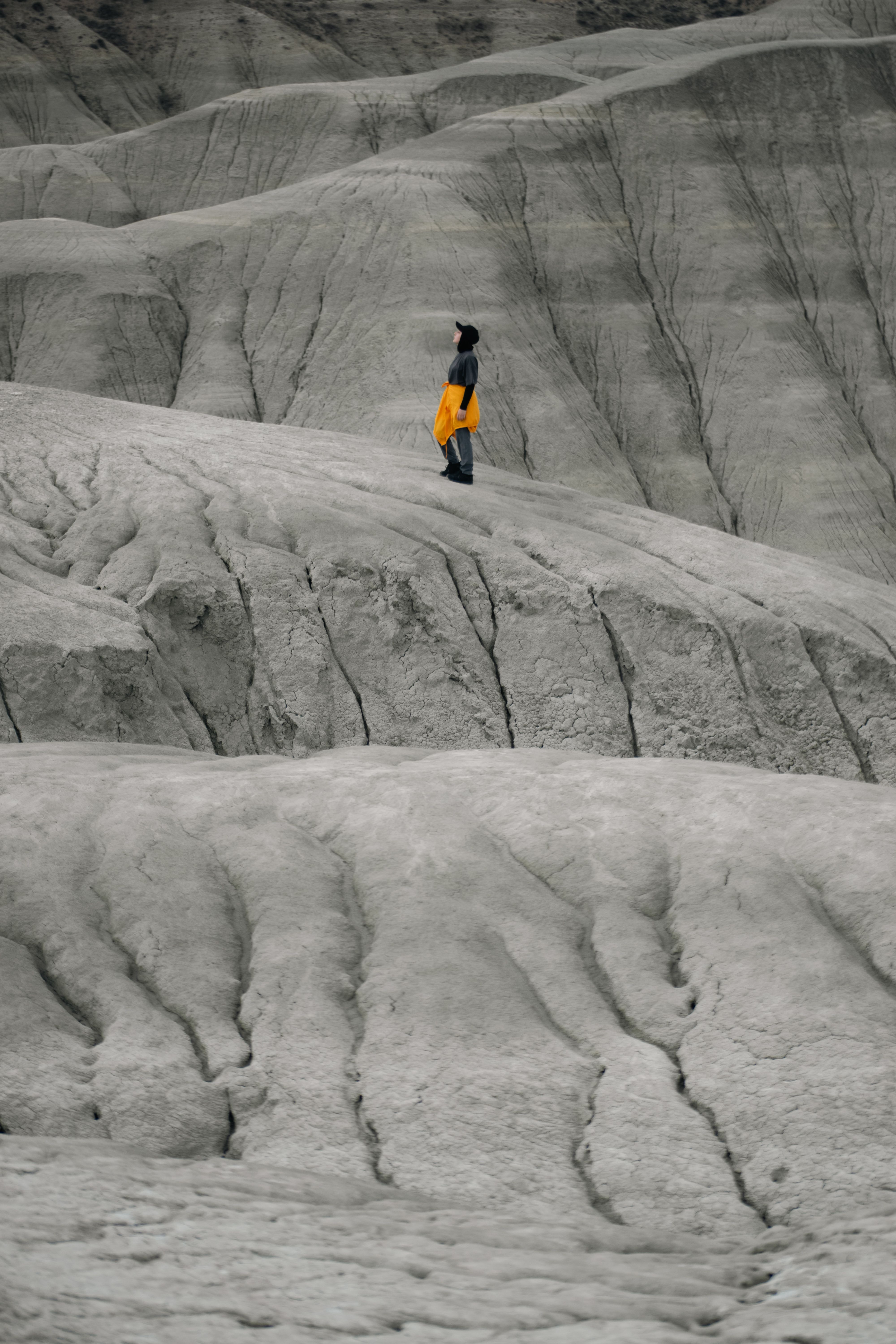 Person in Vibrant Clothing in Desolate Landscape · Free Stock Photo