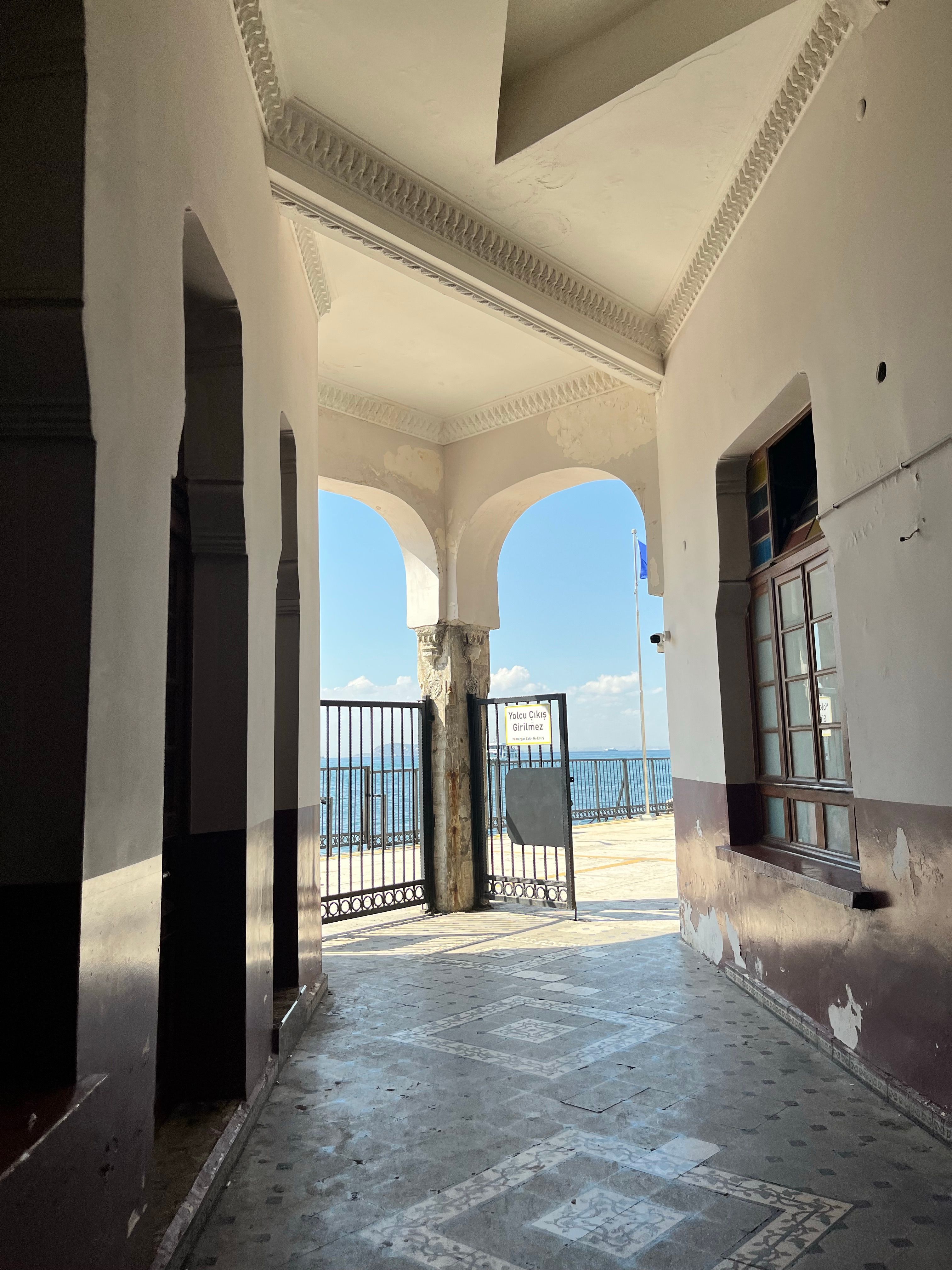 Scenic Ocean View Through Historic Archway · Free Stock Photo
