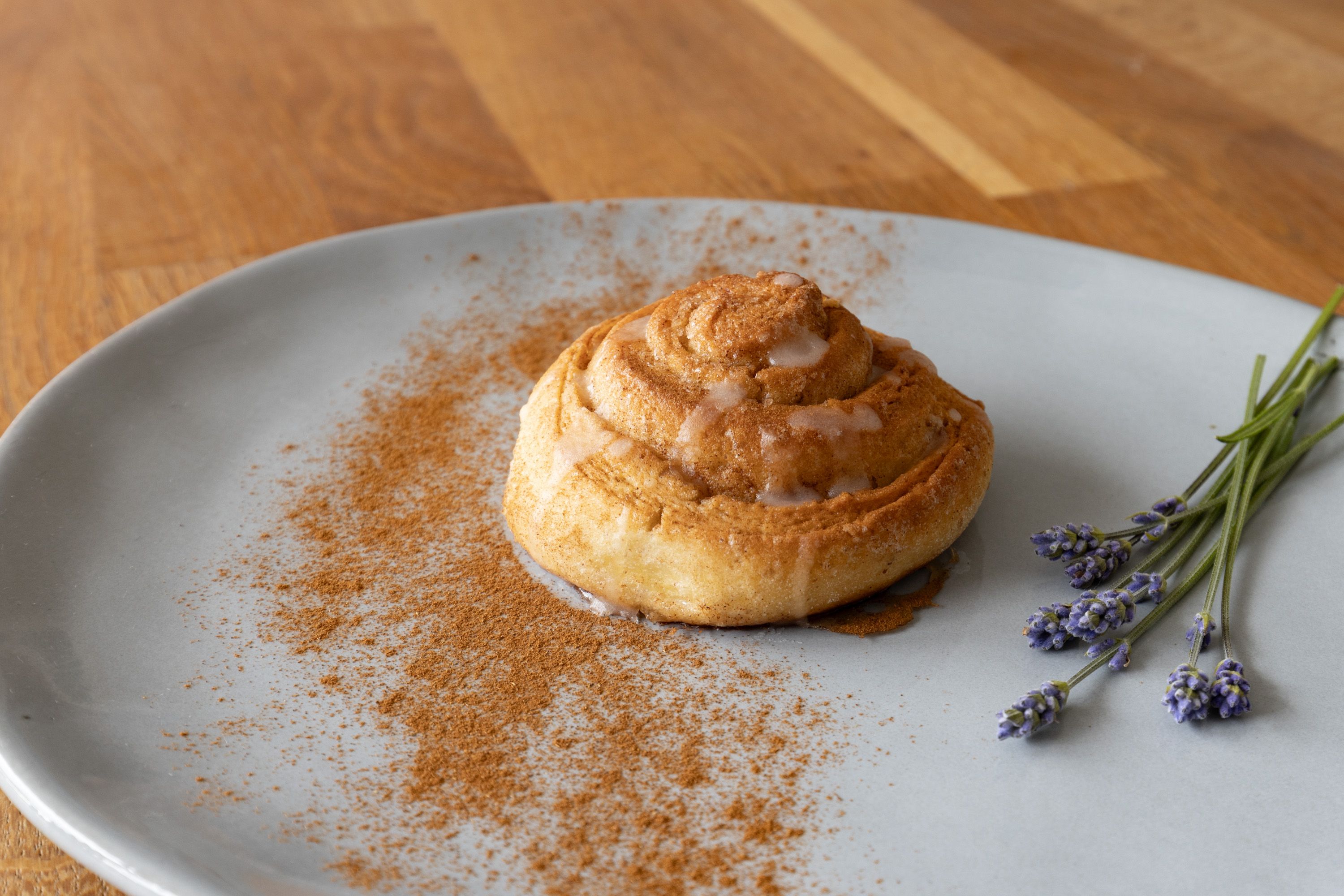 Cinnamon Roll with Lavender on Rustic Plate · Free Stock Photo