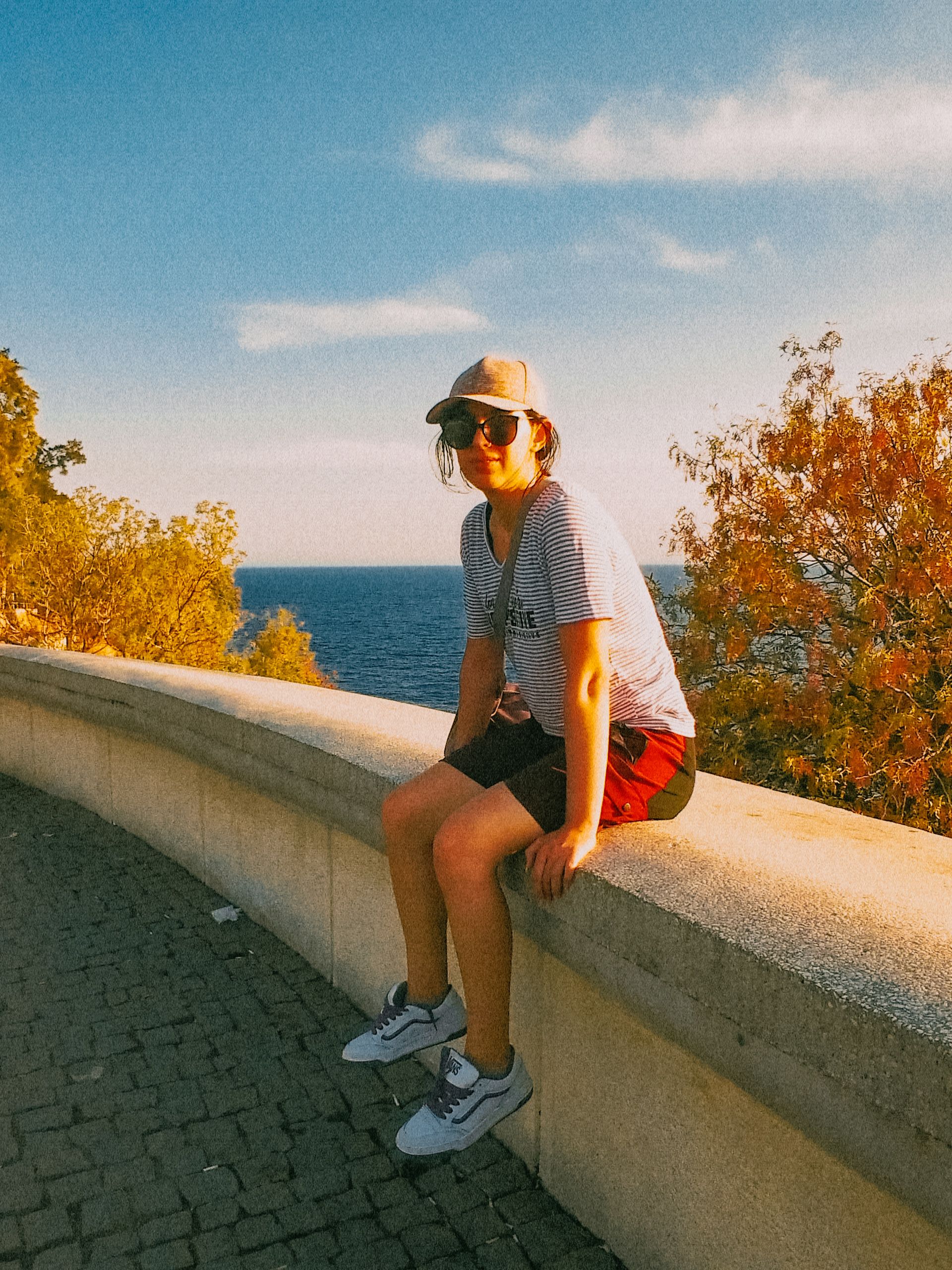 Outdoor Portrait of a Relaxed Traveler by the Sea · Free Stock Photo