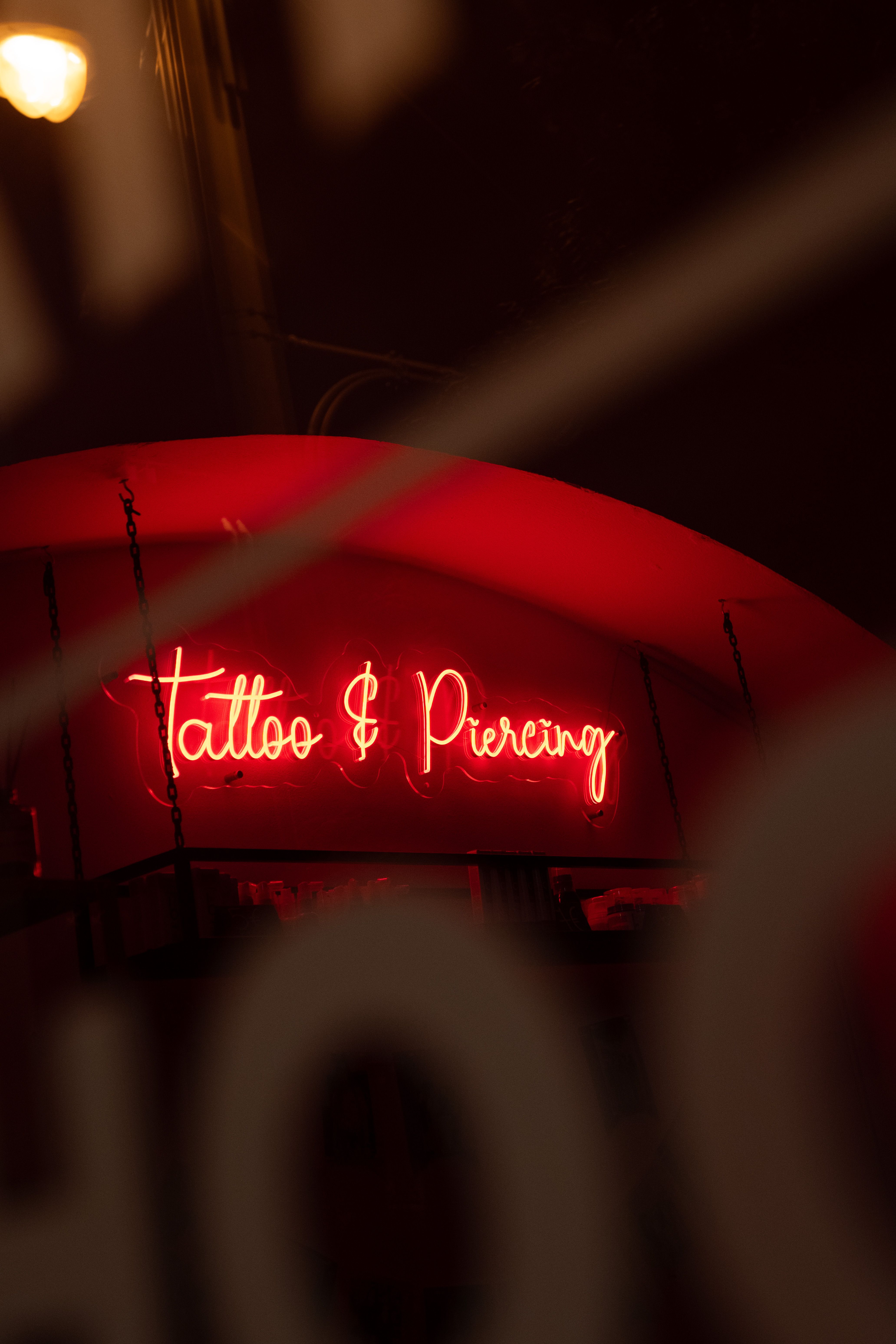 Neon Tattoo & Piercing Sign at Night in Prešov · Free Stock Photo