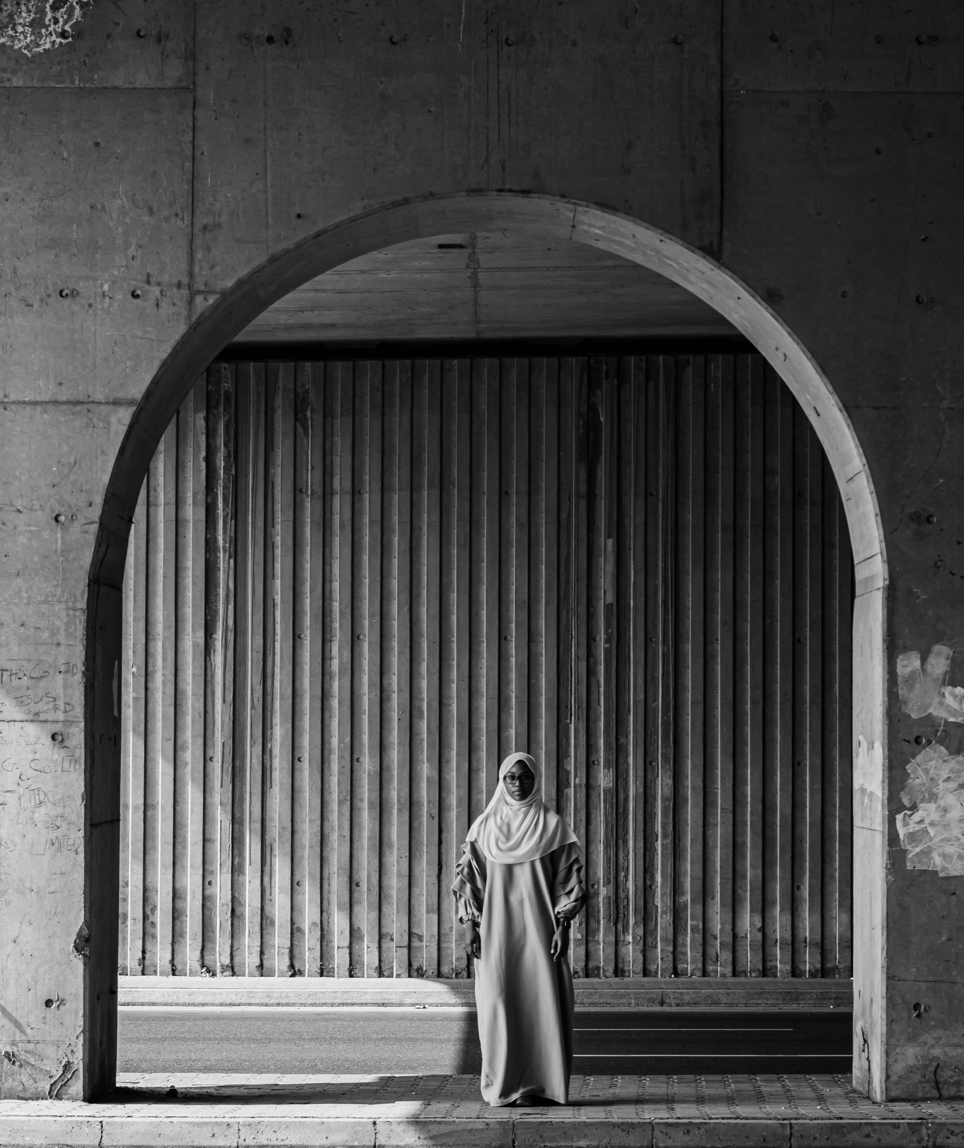Woman in Hijab Under Archway in Urban Setting · Free Stock Photo