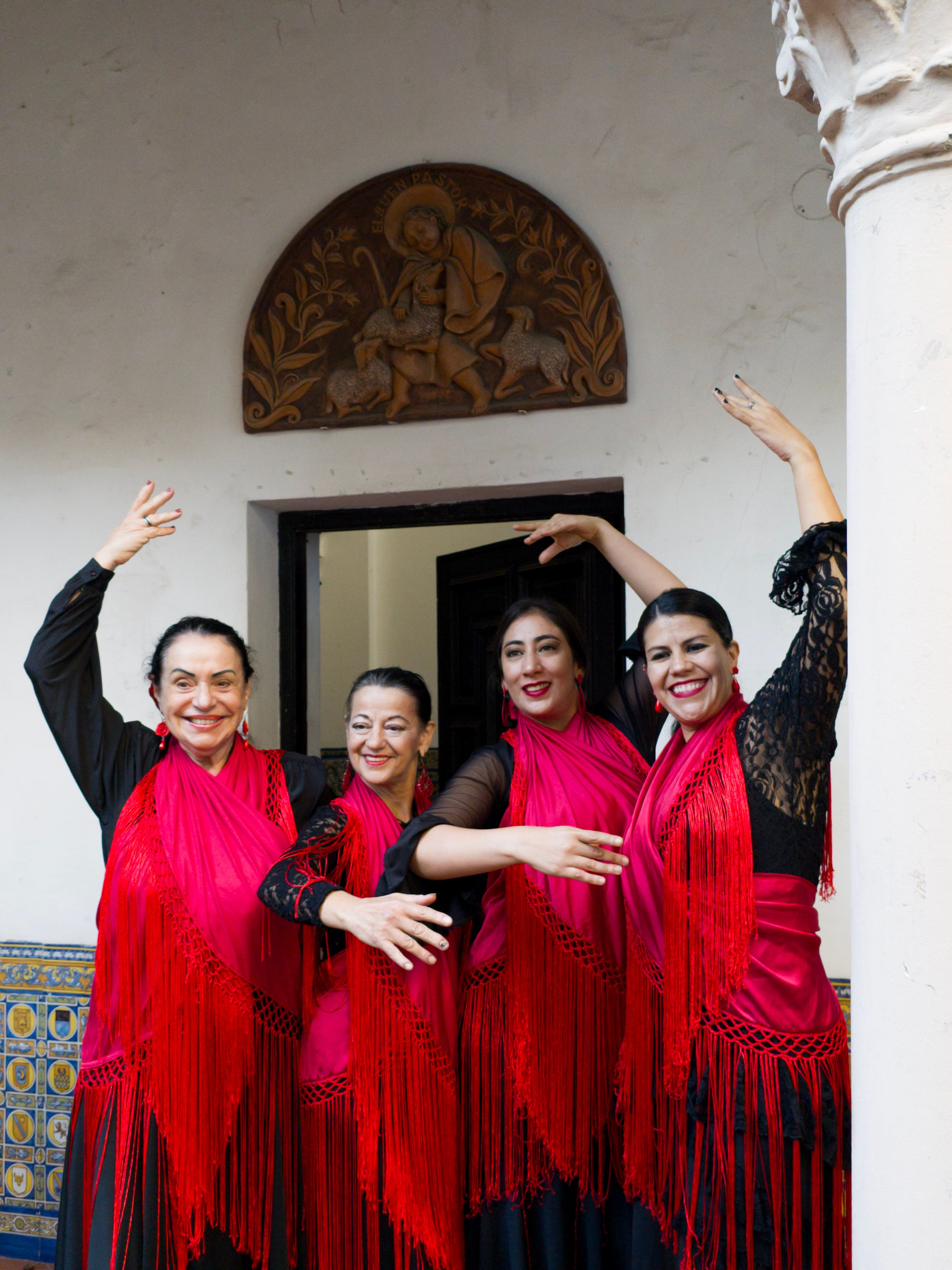 Four Flamenco Dancers in Vibrant Costumes Performing · Free Stock Photo