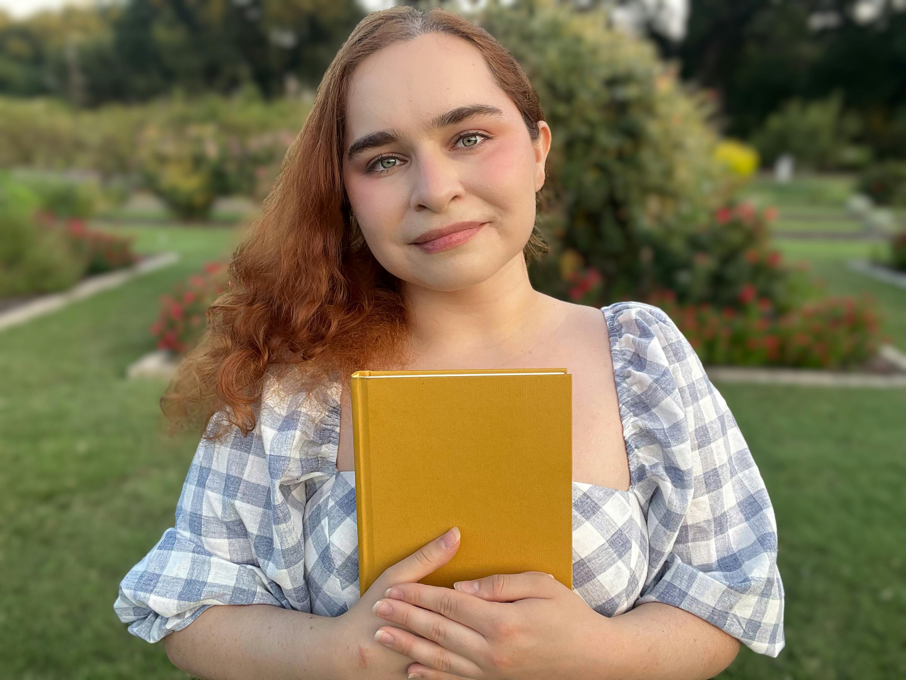 Young Woman Enjoying a Book in a Lush Garden · Free Stock Photo