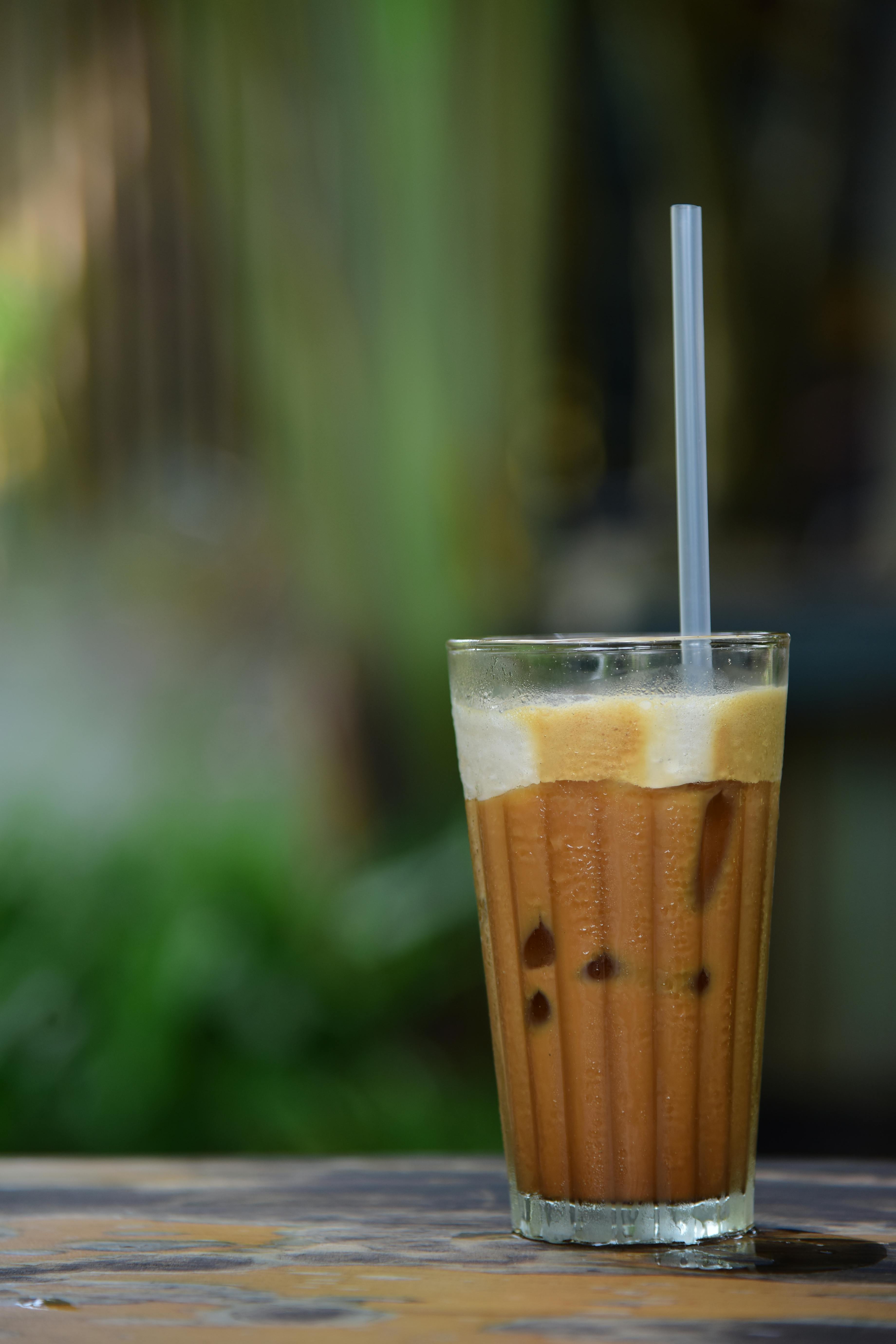 Refreshing Iced Coffee with Straw Outdoors · Free Stock Photo