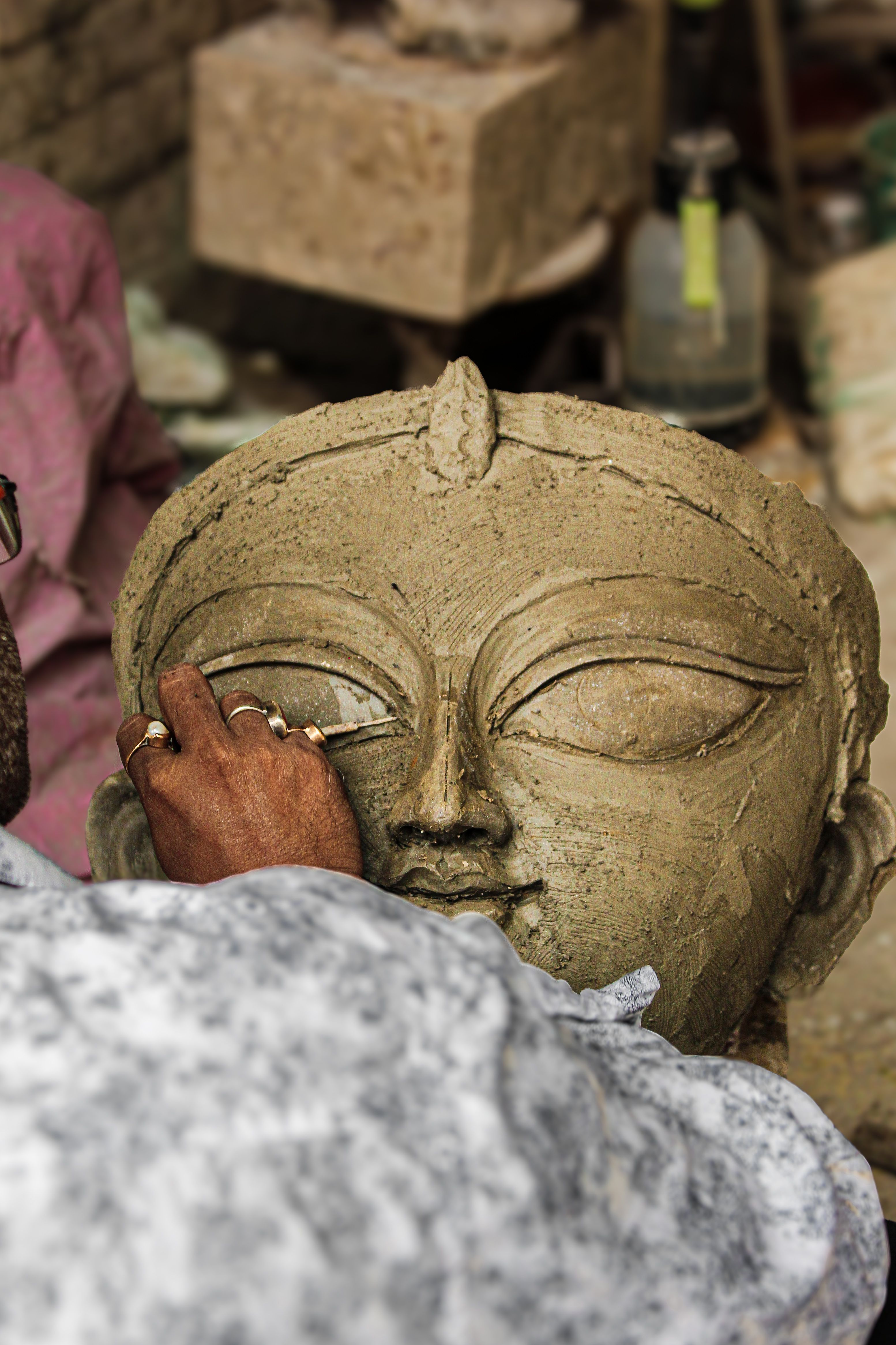 Artisan Sculpting a Clay Buddha Head Statue · Free Stock Photo