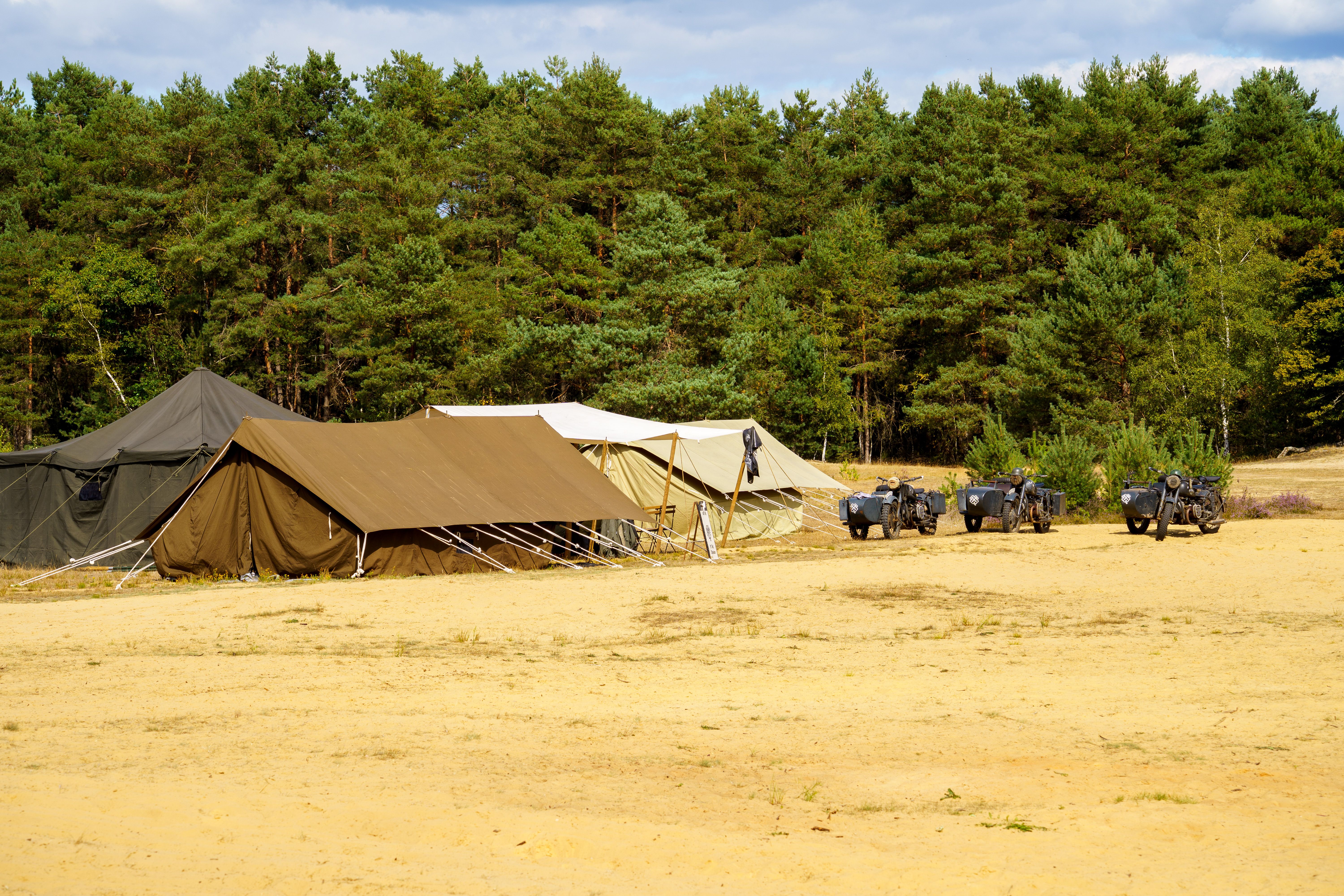 Military Camp with Tents and Motorcycles in Forrest · Free Stock Photo