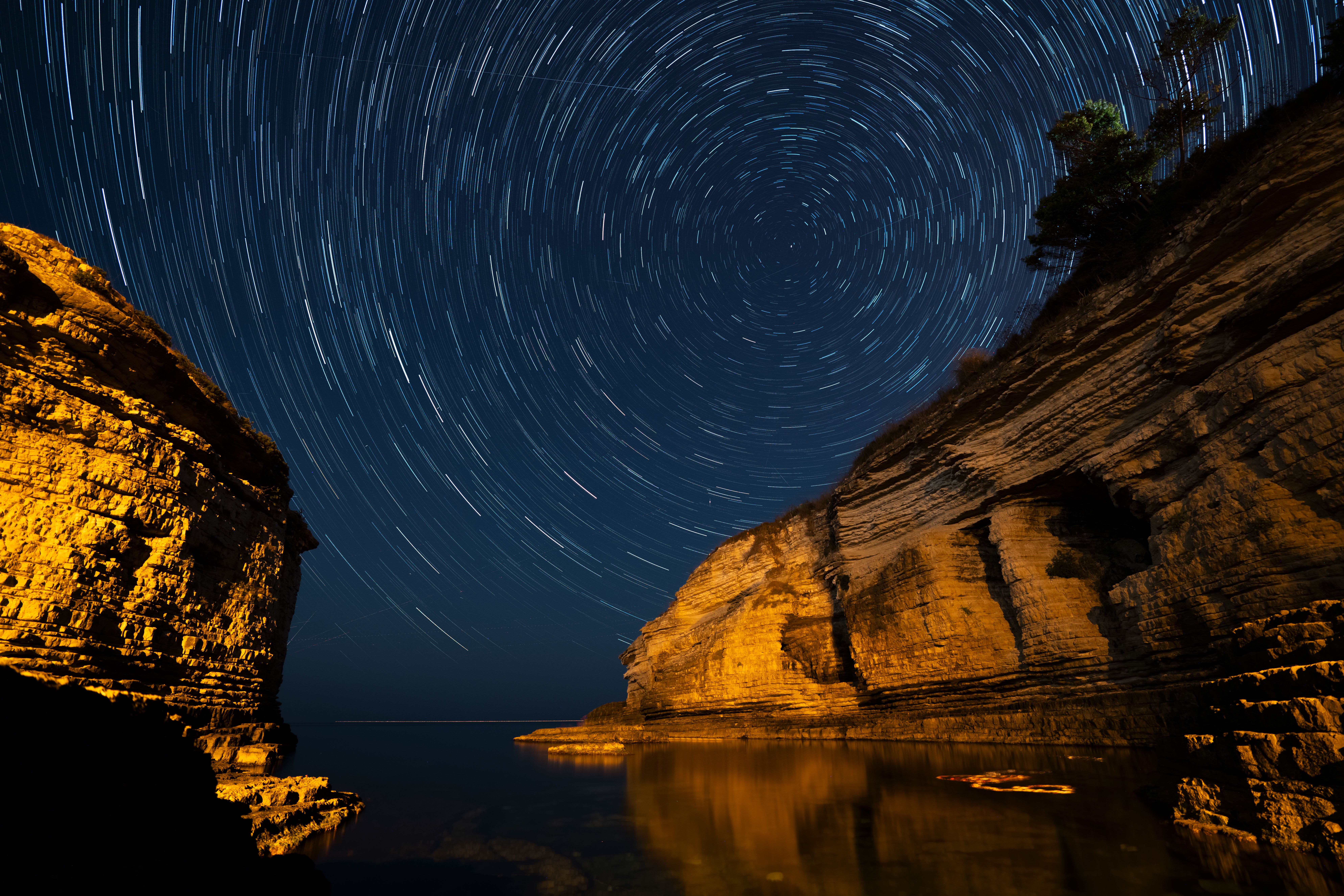Stunning Star Trails Over Rocky Coastal Cliffs · Free Stock Photo