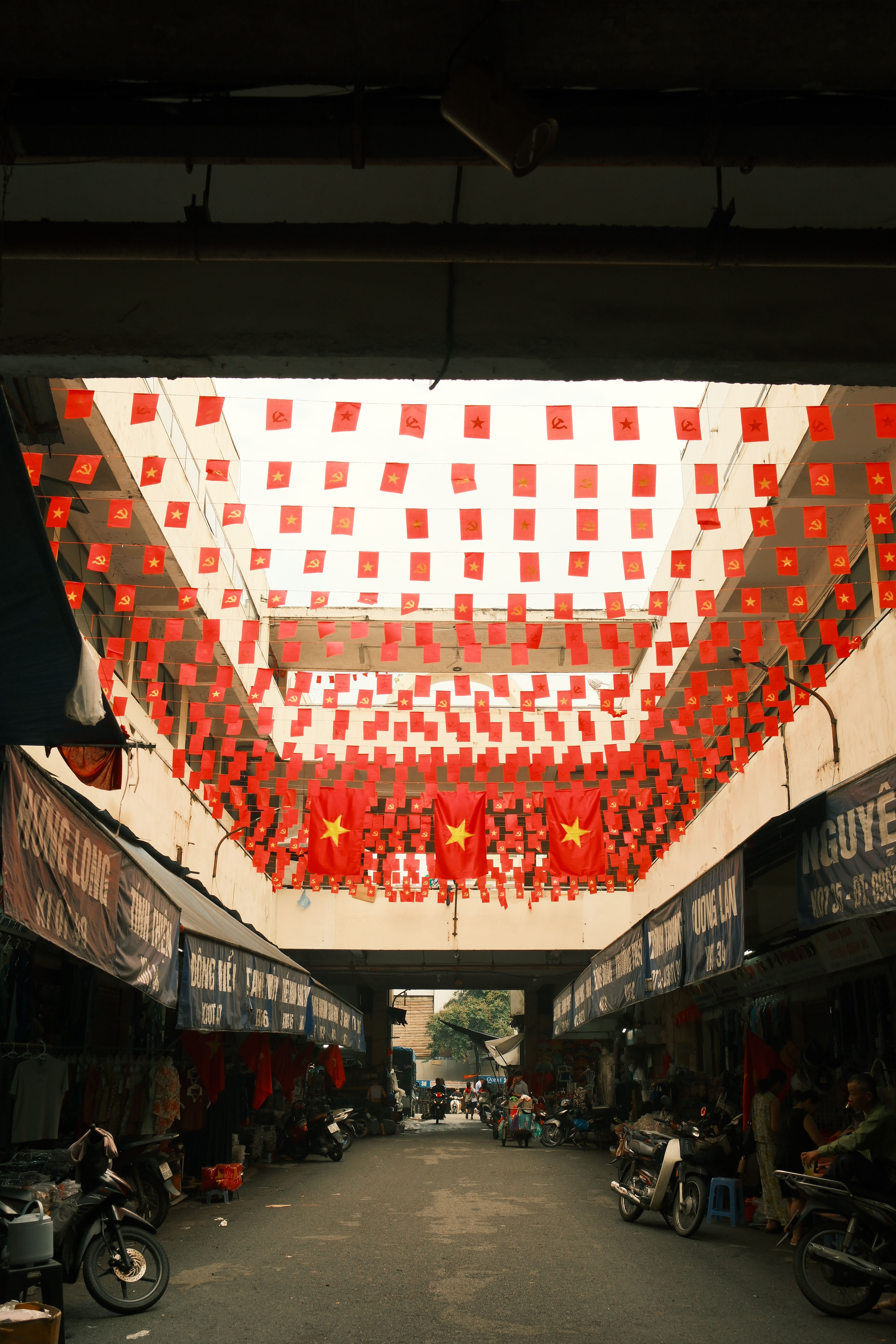 Vibrant Market Corridor Decorated with Flags · Free Stock Photo