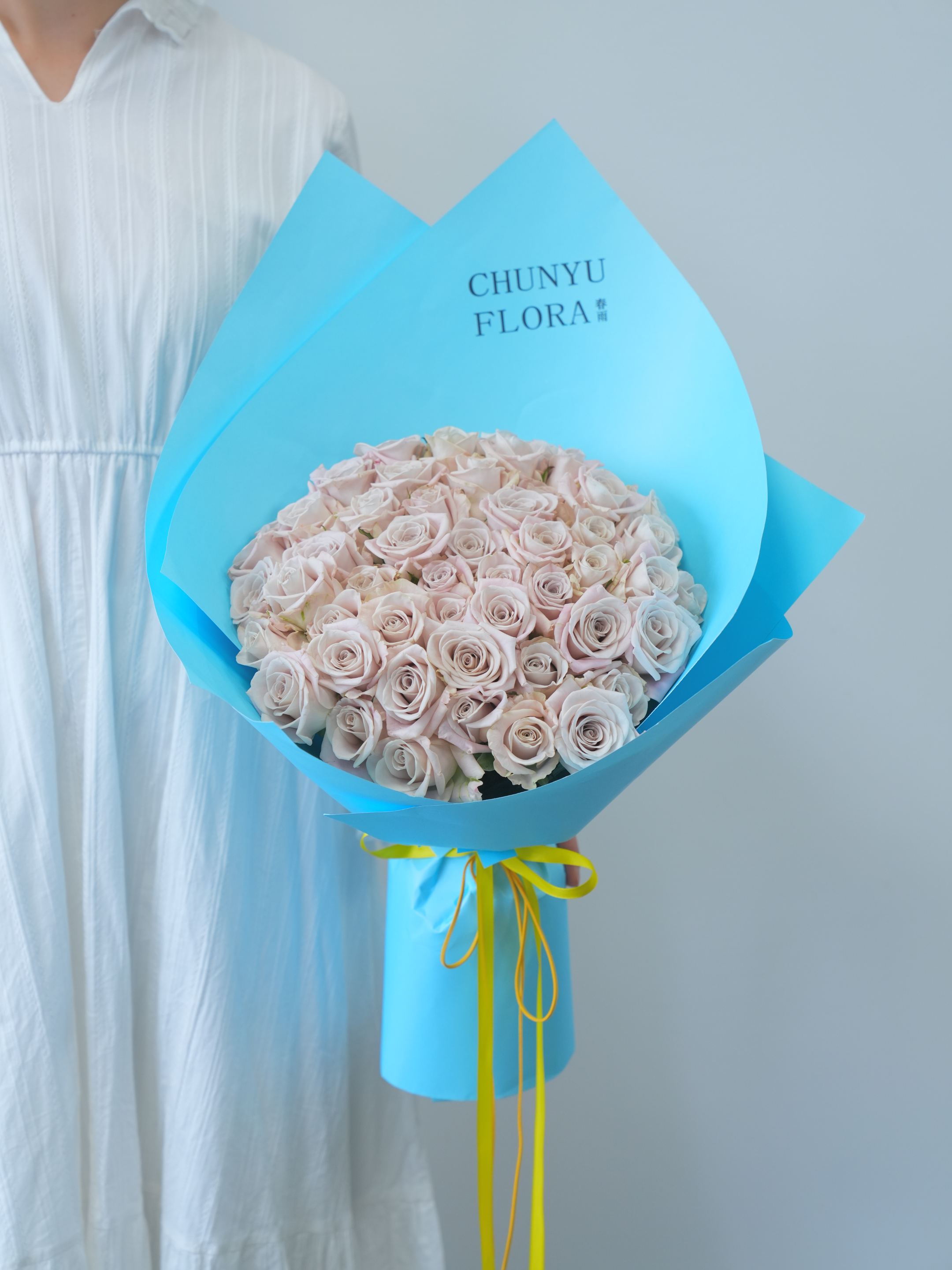Elegant Bouquet of Pink Roses with Blue Wrapper · Free Stock Photo