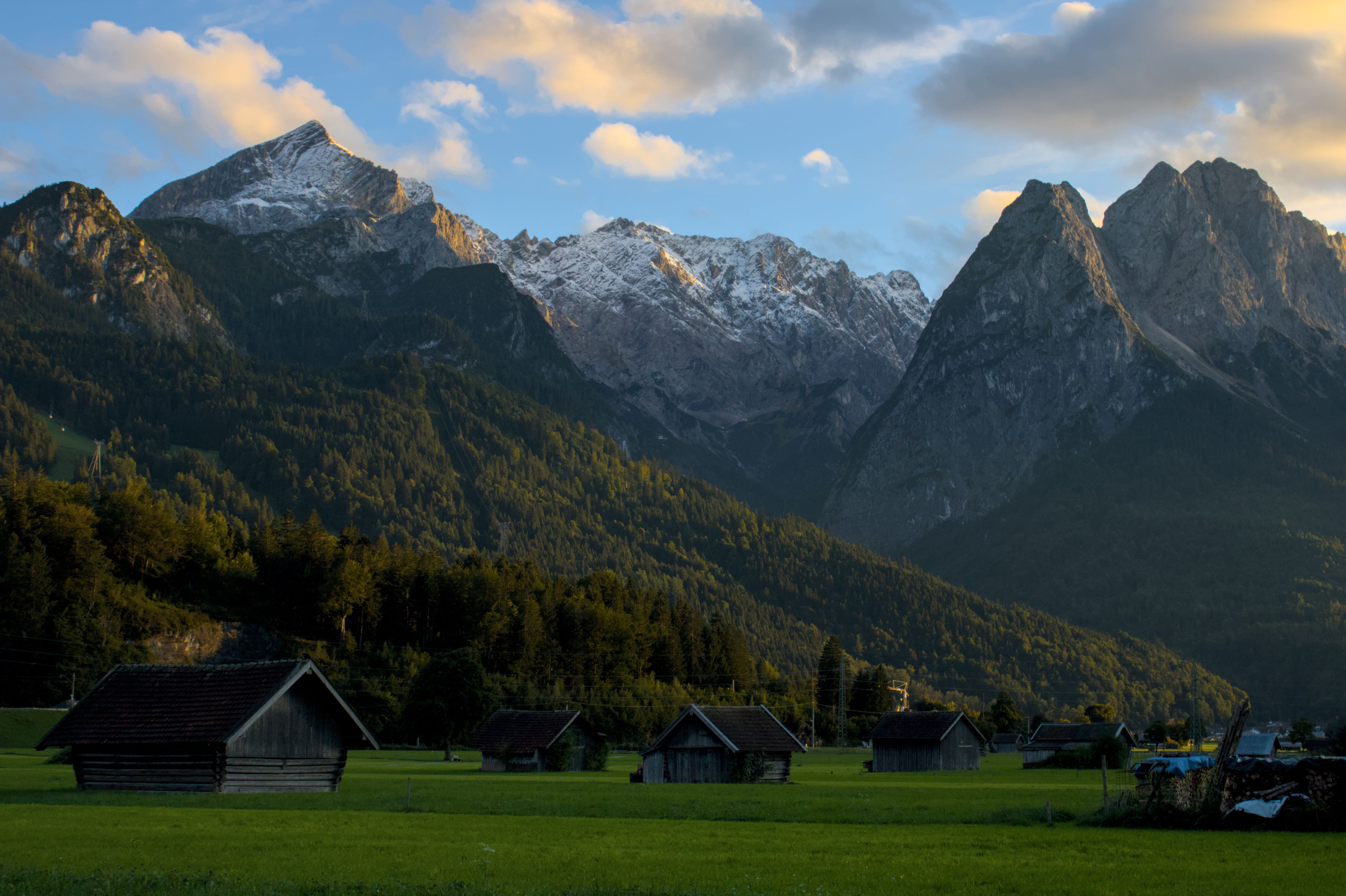 Scenic Alpine Landscape with Rustic Cabins at Sunrise · Free Stock Photo