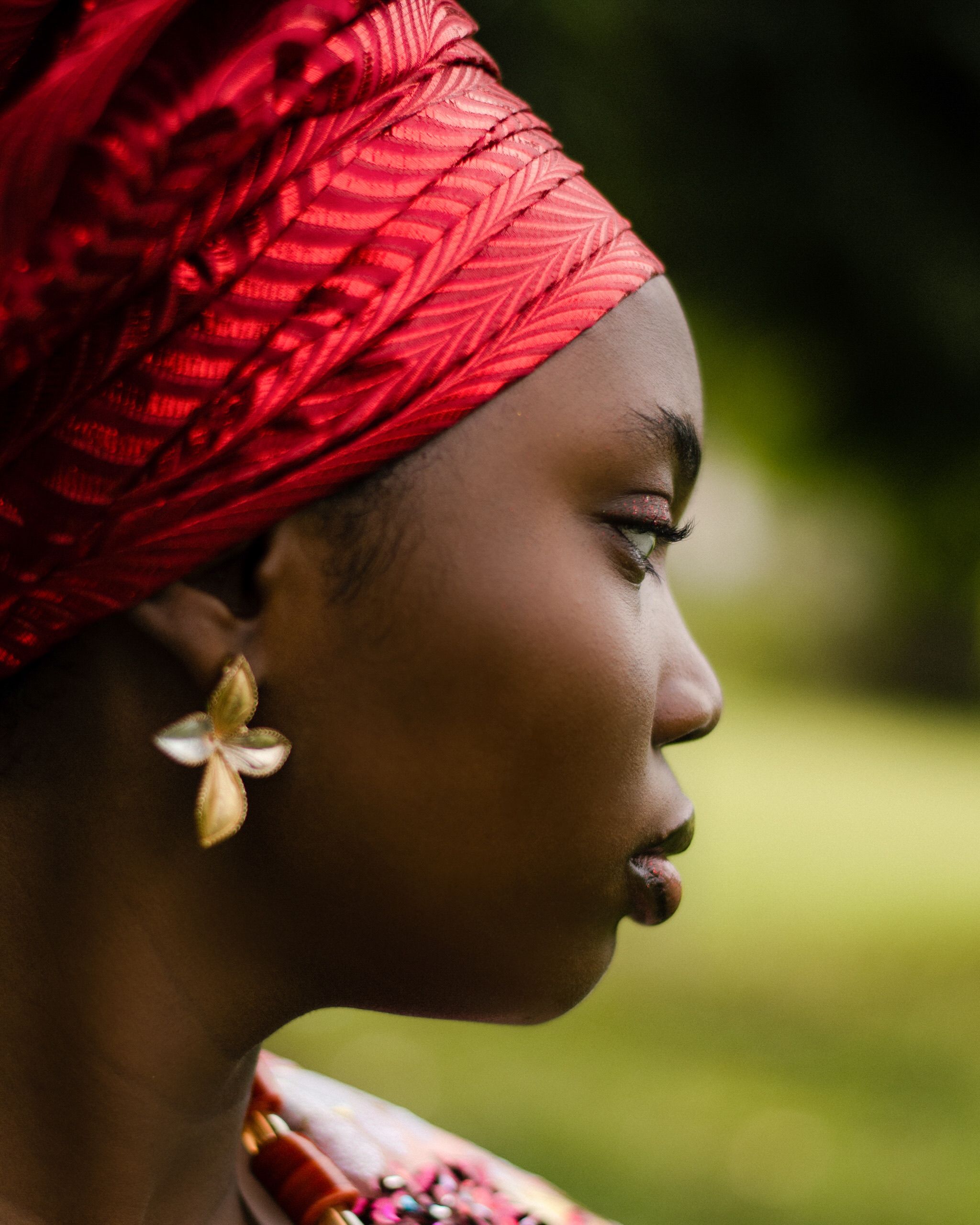 Portrait of Woman in Red Head Wrap Outdoors · Free Stock Photo