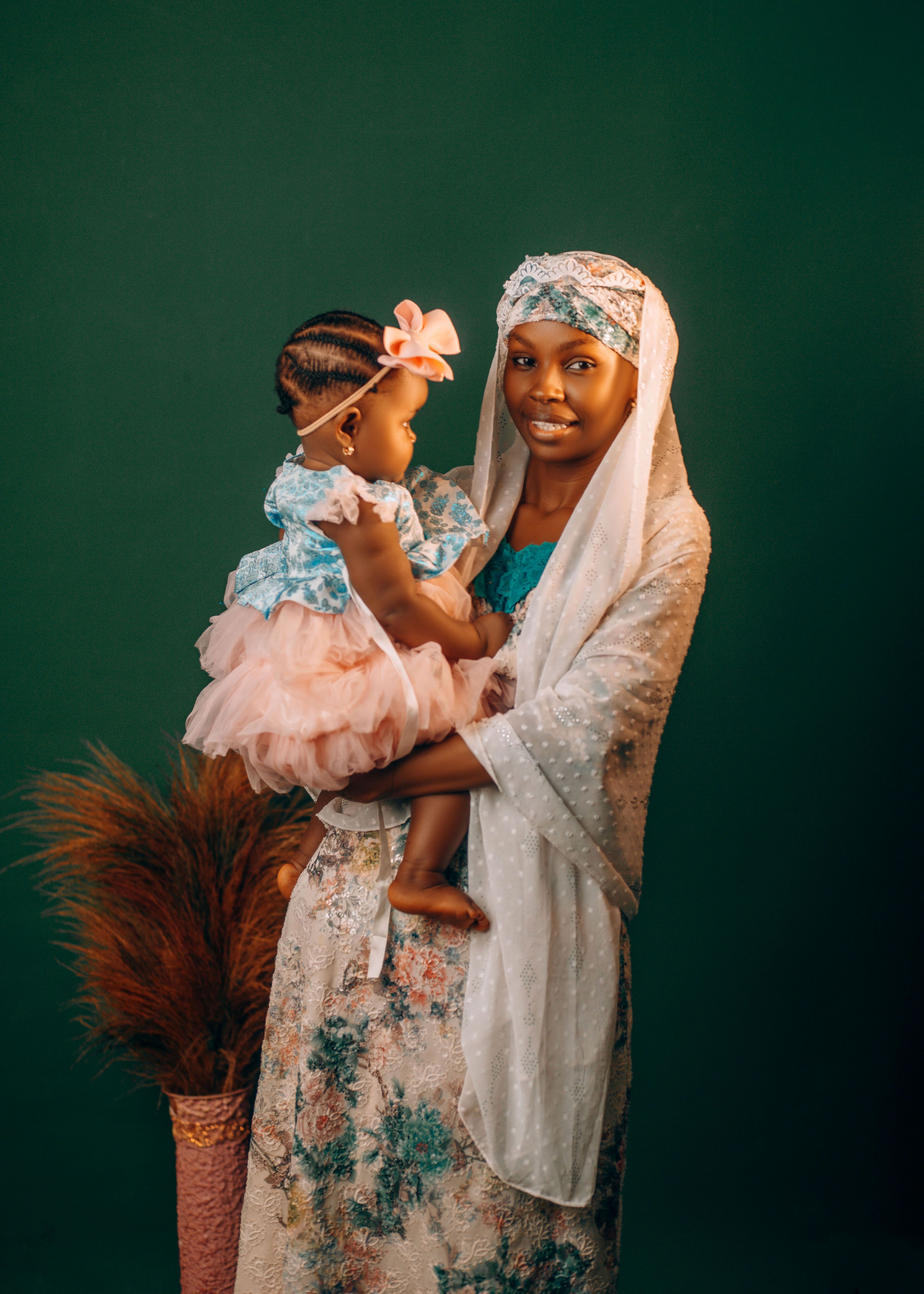 African Mother Holding Baby in Traditional Attire · Free Stock Photo