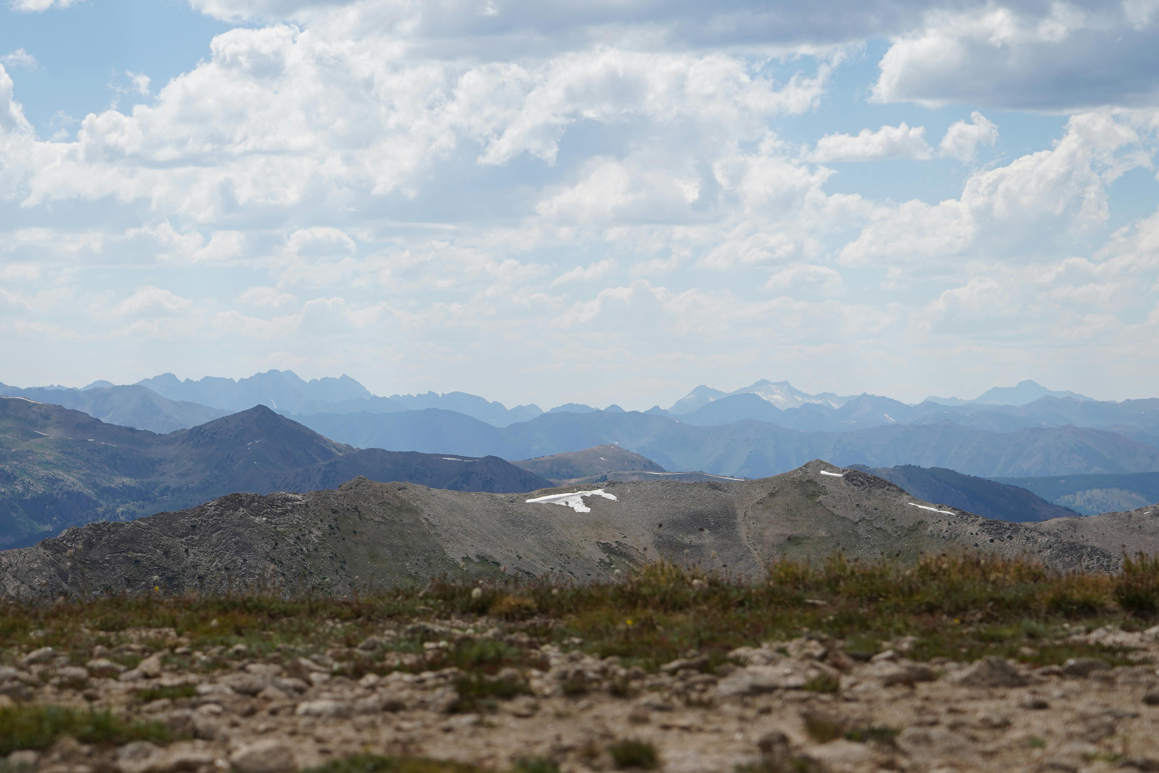 Expansive Mountain Range Under Cloudy Sky · Free Stock Photo