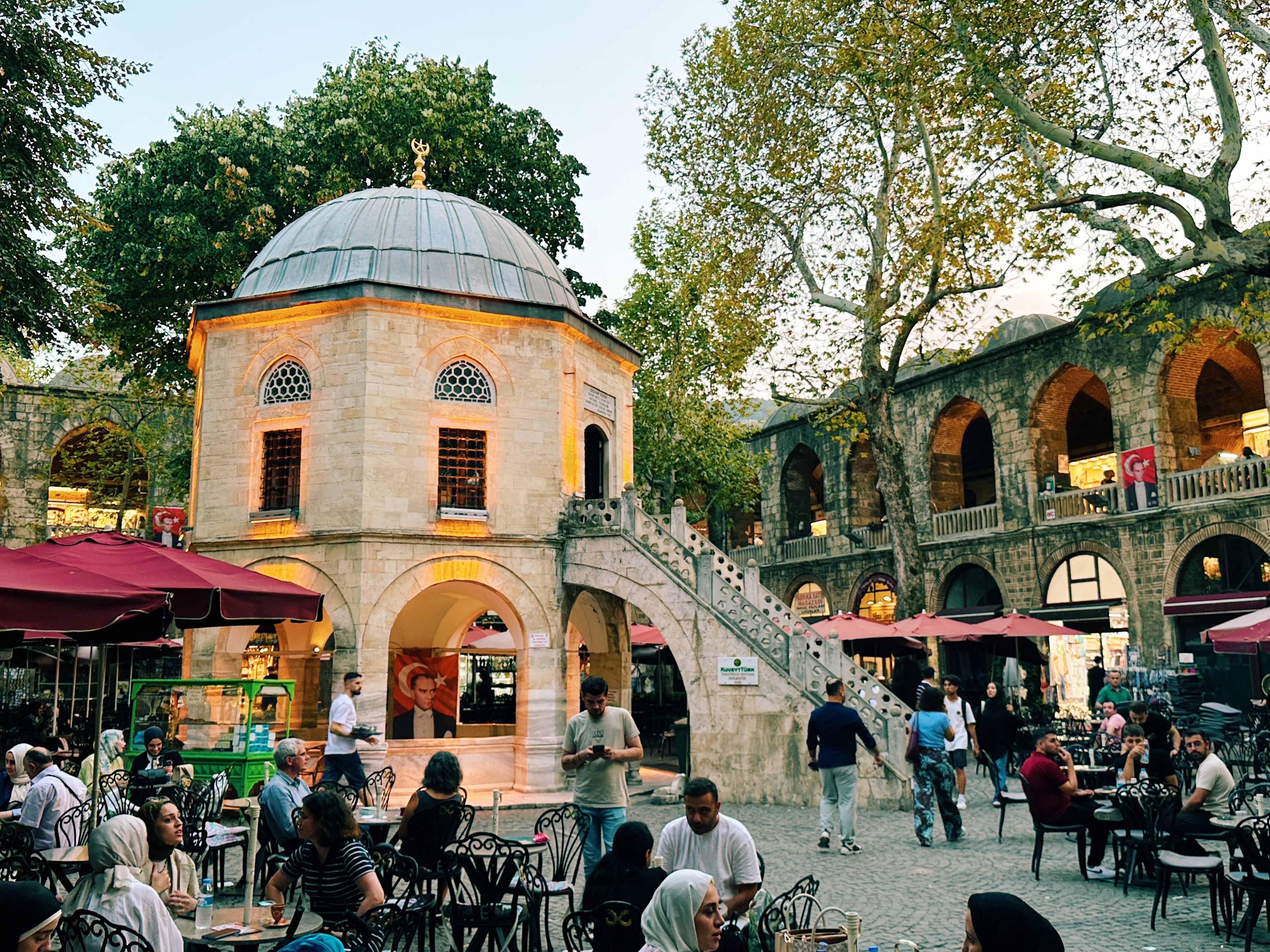 Vibrant Outdoor Cafe Scene in Historic Marketplace · Free Stock Photo