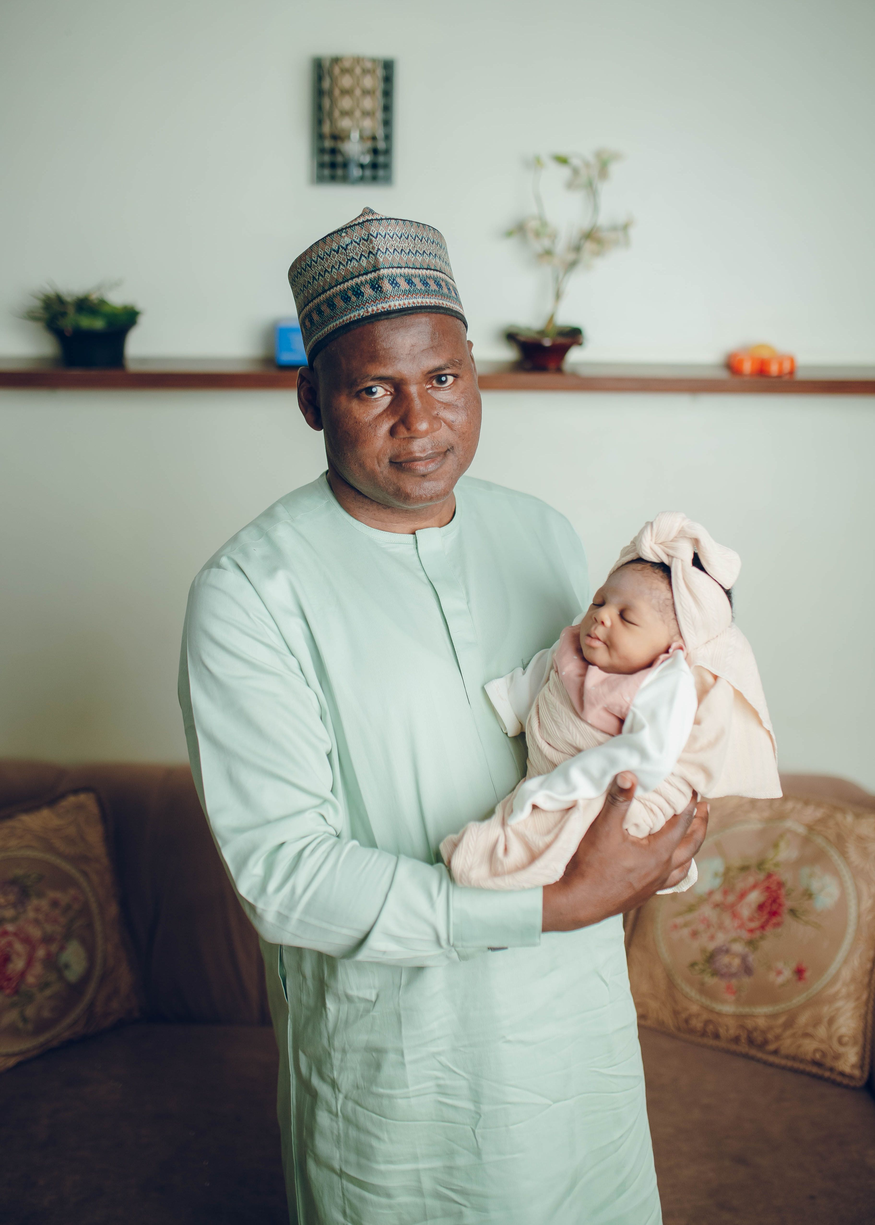 Father Holding Newborn in Traditional Nigerian Attire · Free Stock Photo