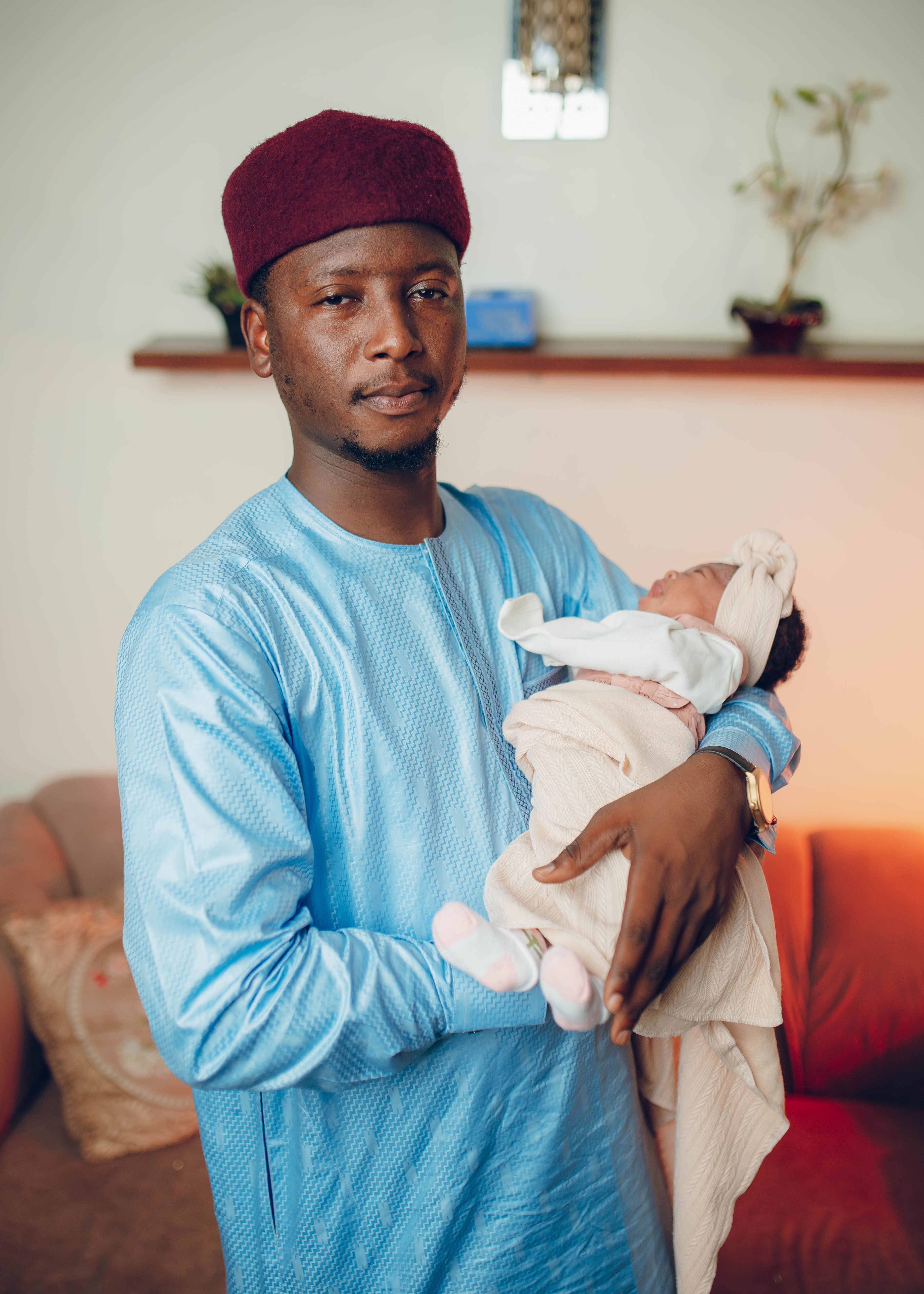 Nigerian Father Holding Newborn in Traditional Attire · Free Stock Photo