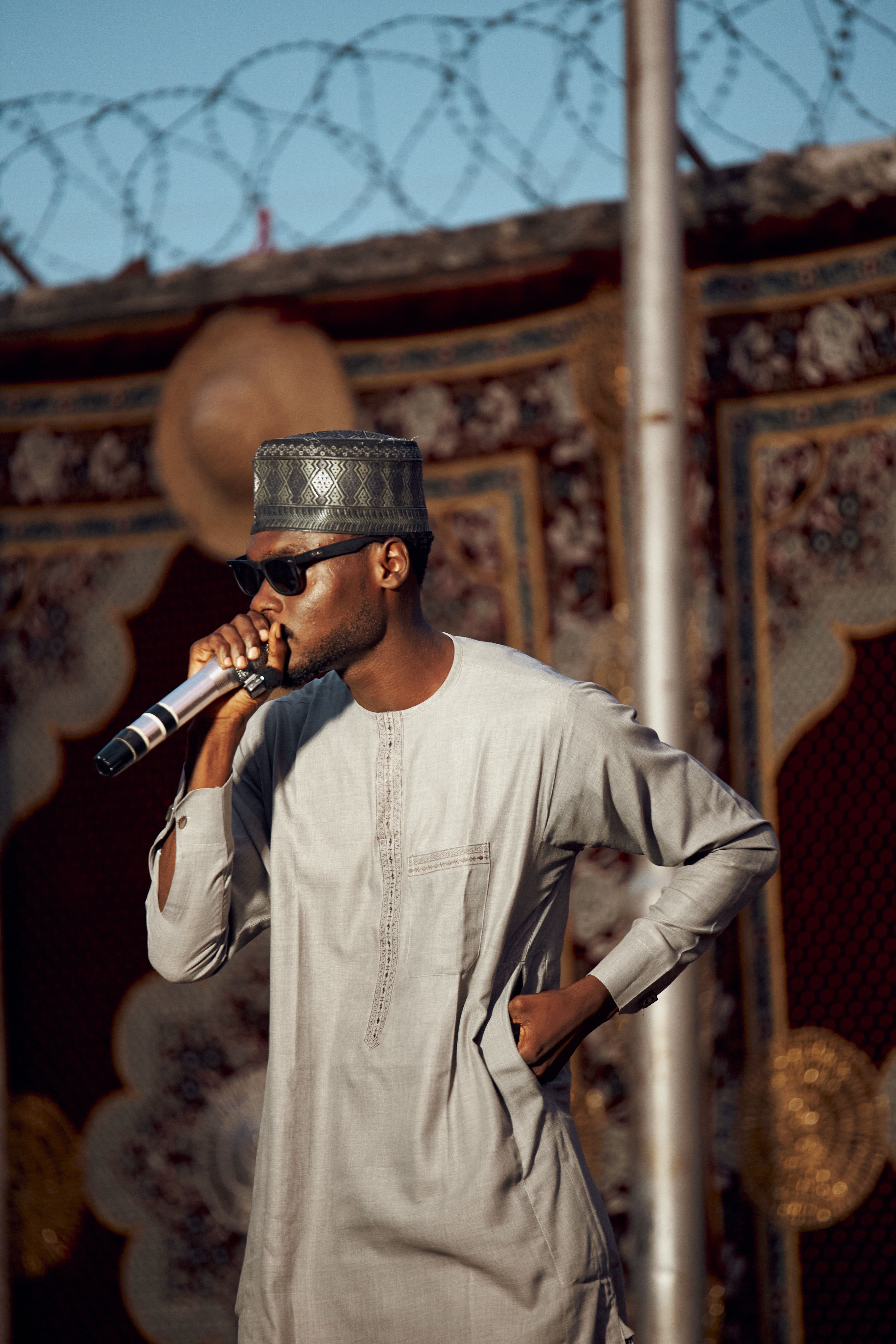 Street Performer Singing with Microphone Outdoors · Free Stock Photo