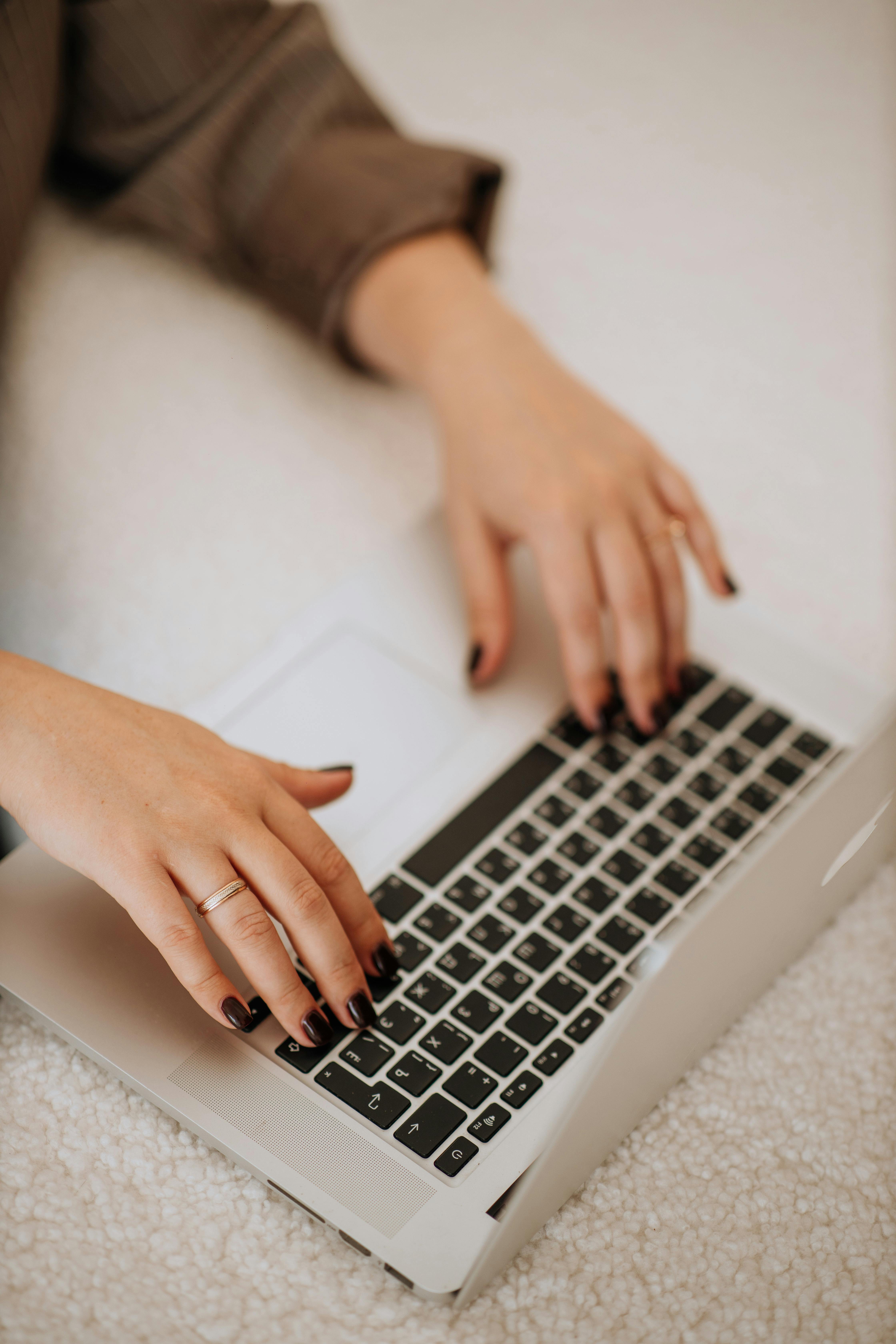 Woman's Hands Typing on Laptop Keyboard · Free Stock Photo
