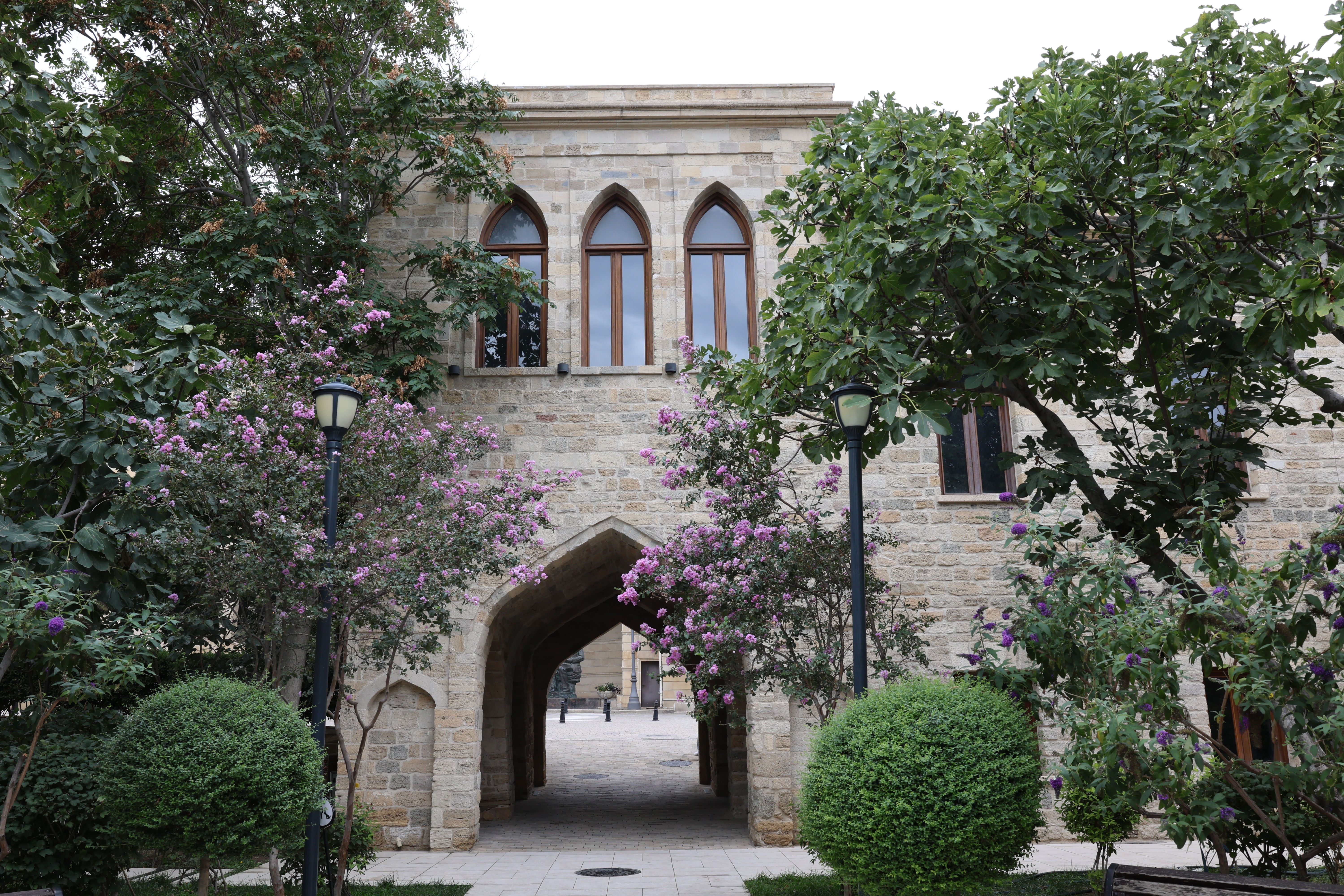 Historic Stone Architecture with Lush Greenery · Free Stock Photo