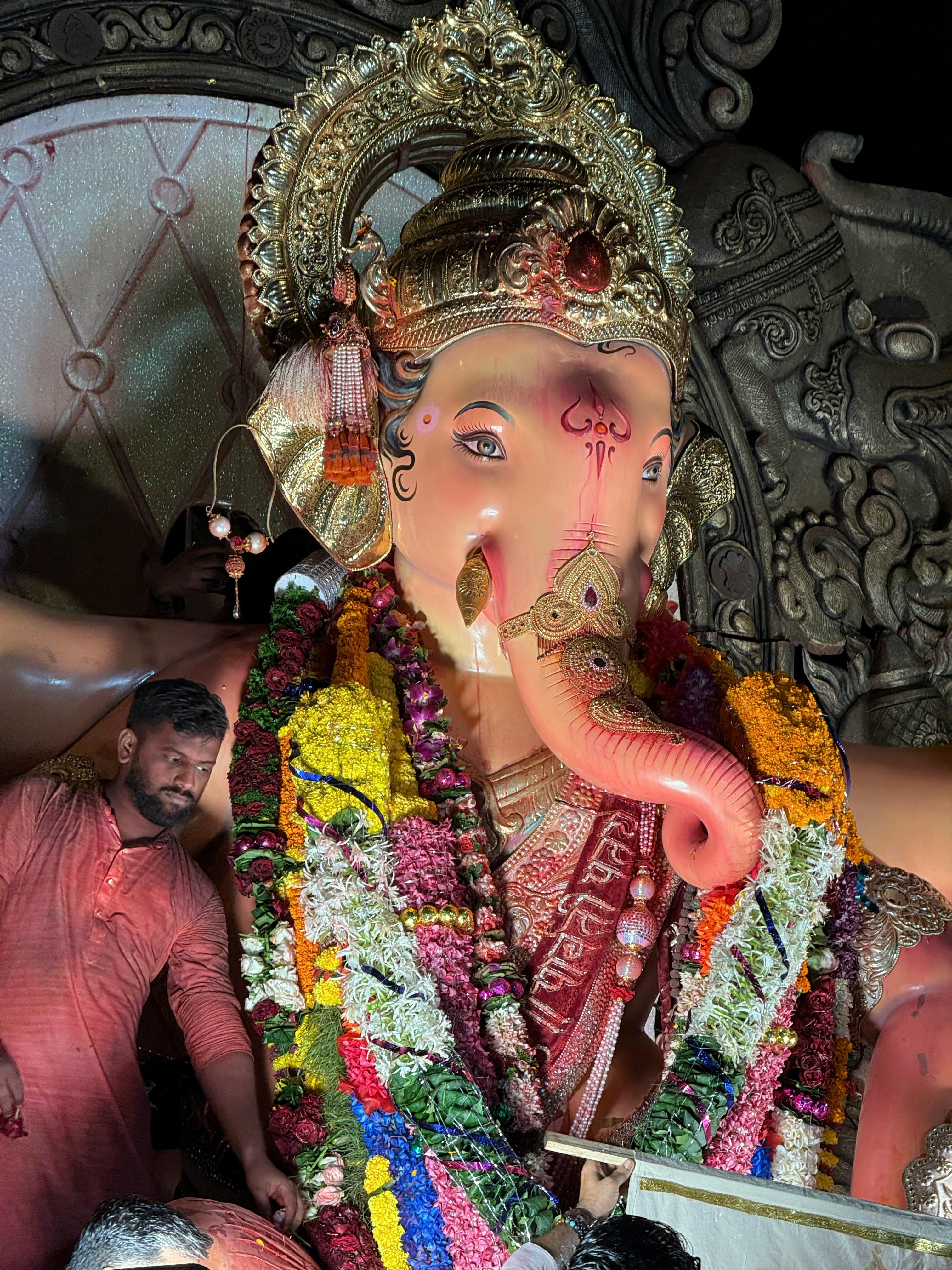 Colorful Ganesh Statue with Devotee During Festival · Free Stock Photo