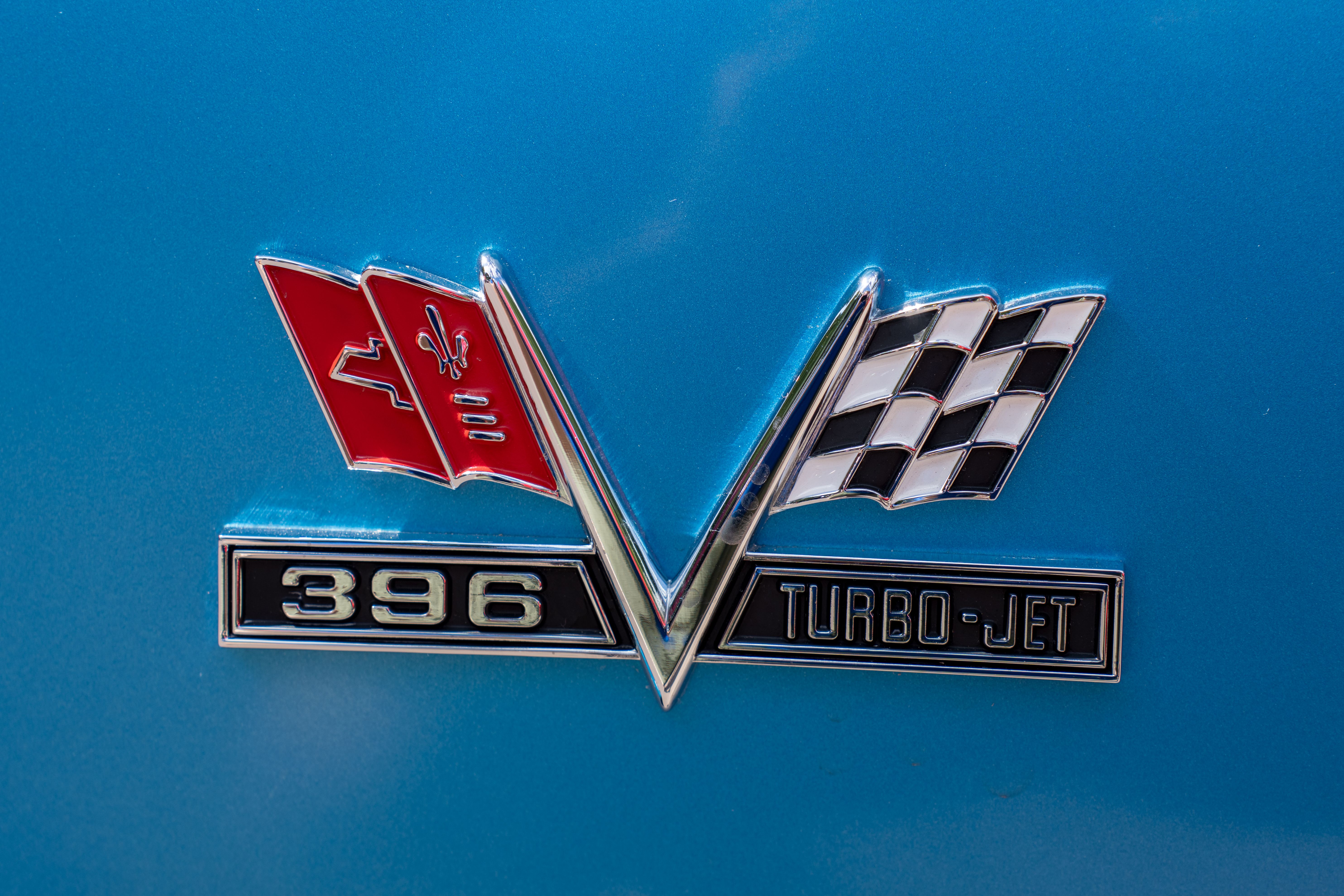 Classic Car Emblem on Blue Vehicle Surface · Free Stock Photo