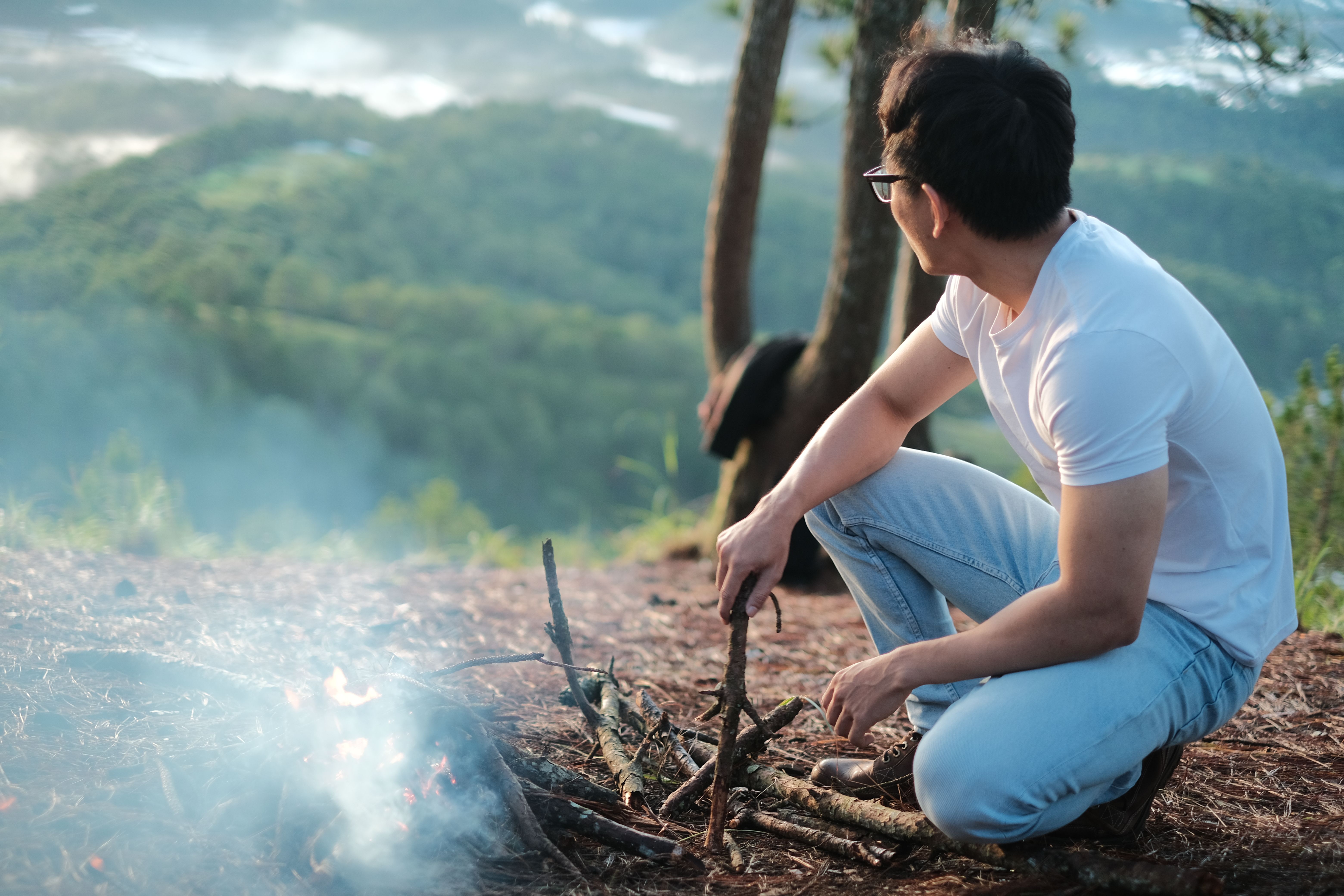 Man Hiking with Campfire in Scenic Mountain View · Free Stock Photo