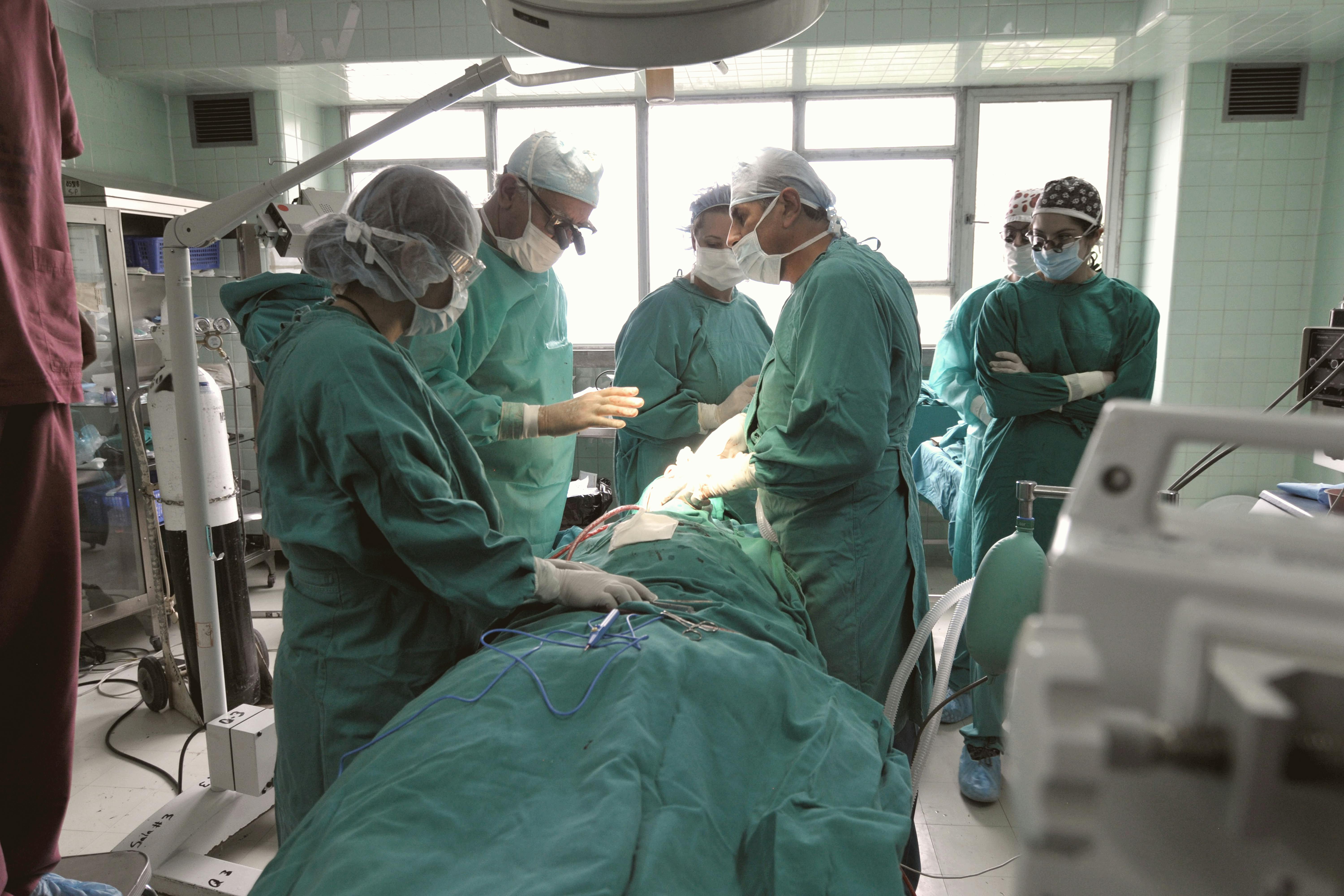Medical Team Performing Surgery in Operating Room · Free Stock Photo