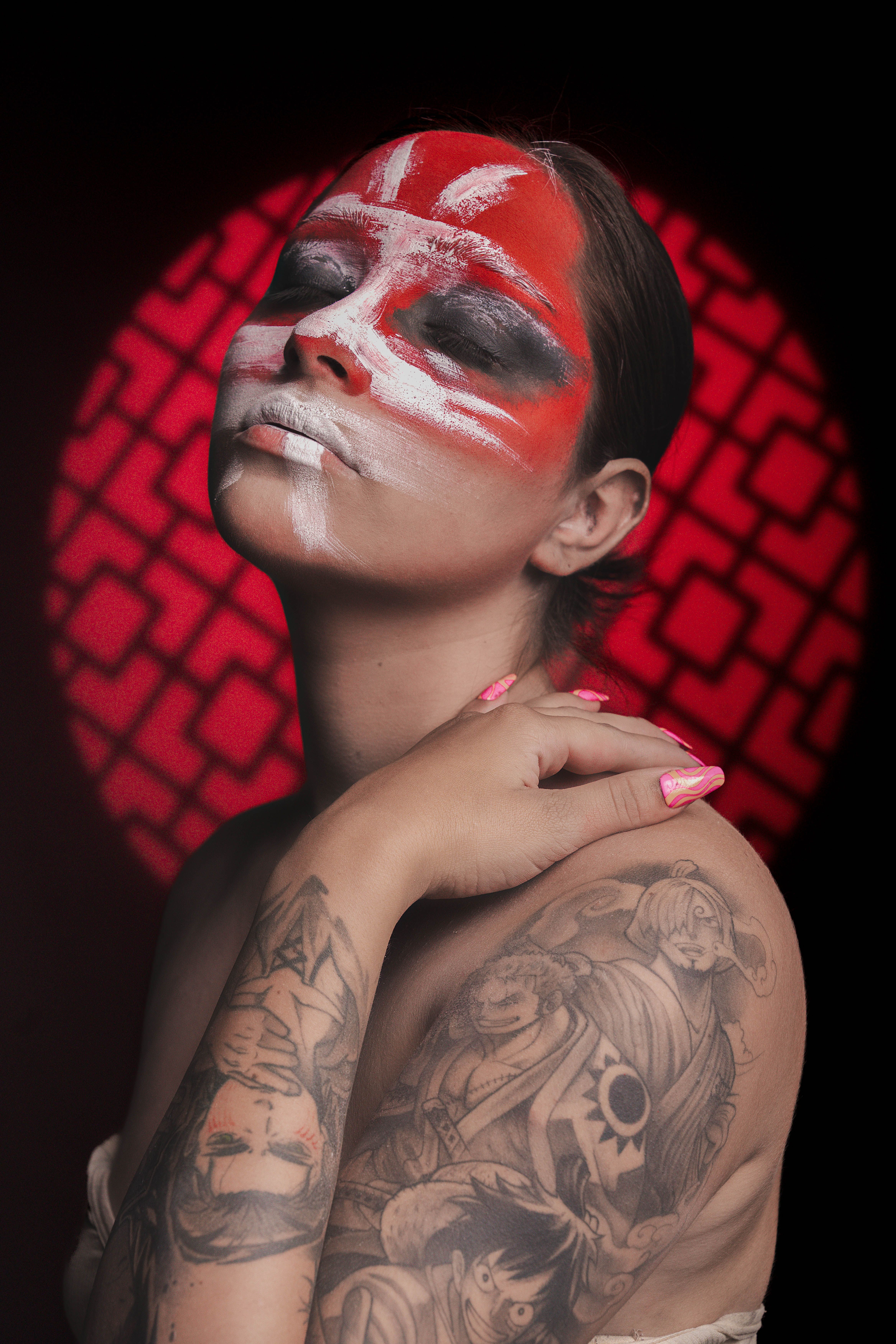 Portrait of Woman with Dramatic Face Paint and Tattoos · Free Stock Photo