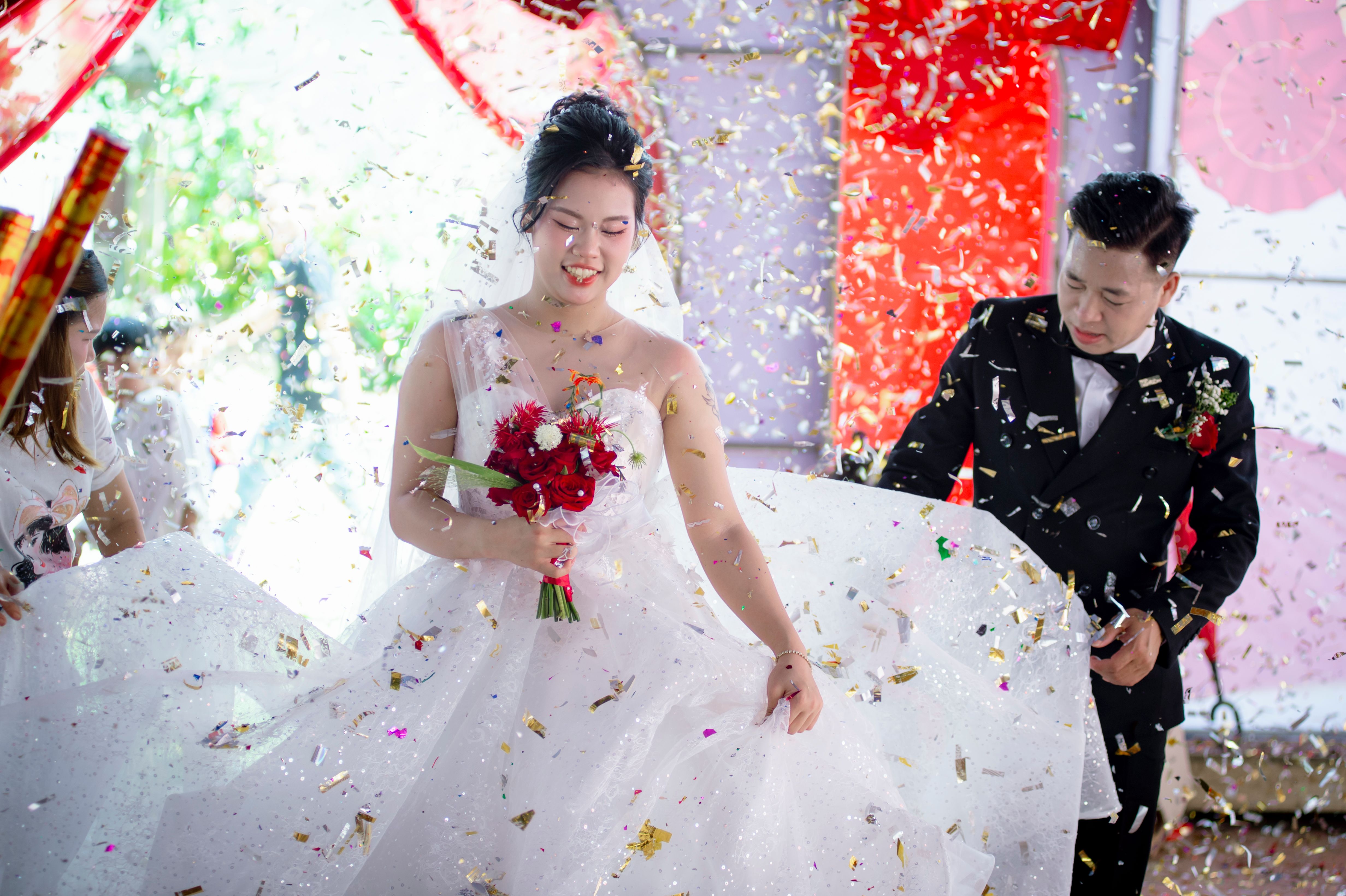 Joyful Vietnamese Wedding Celebration with Confetti · Free Stock Photo