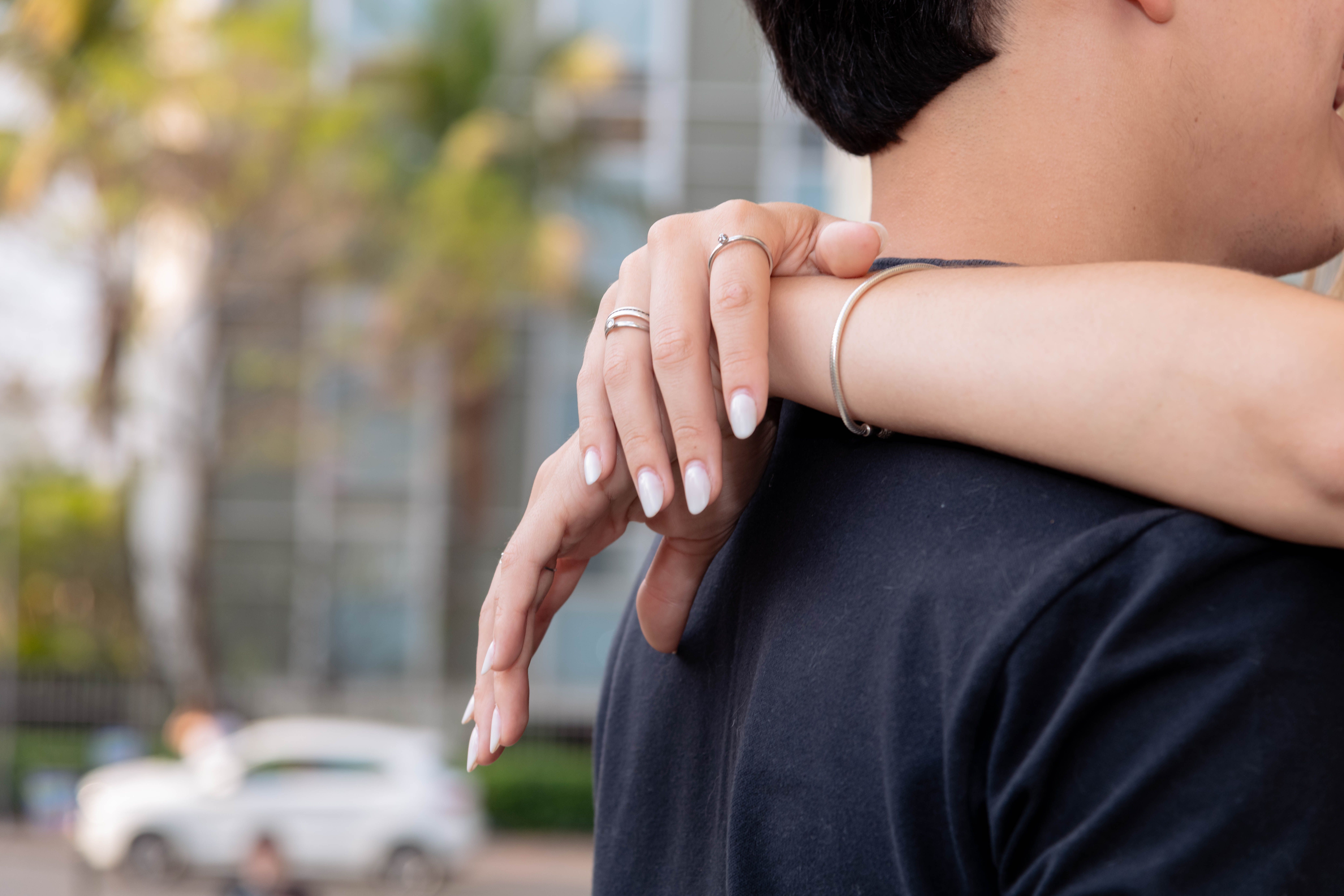 Romantic Embrace with Ringed Hands Outdoors · Free Stock Photo