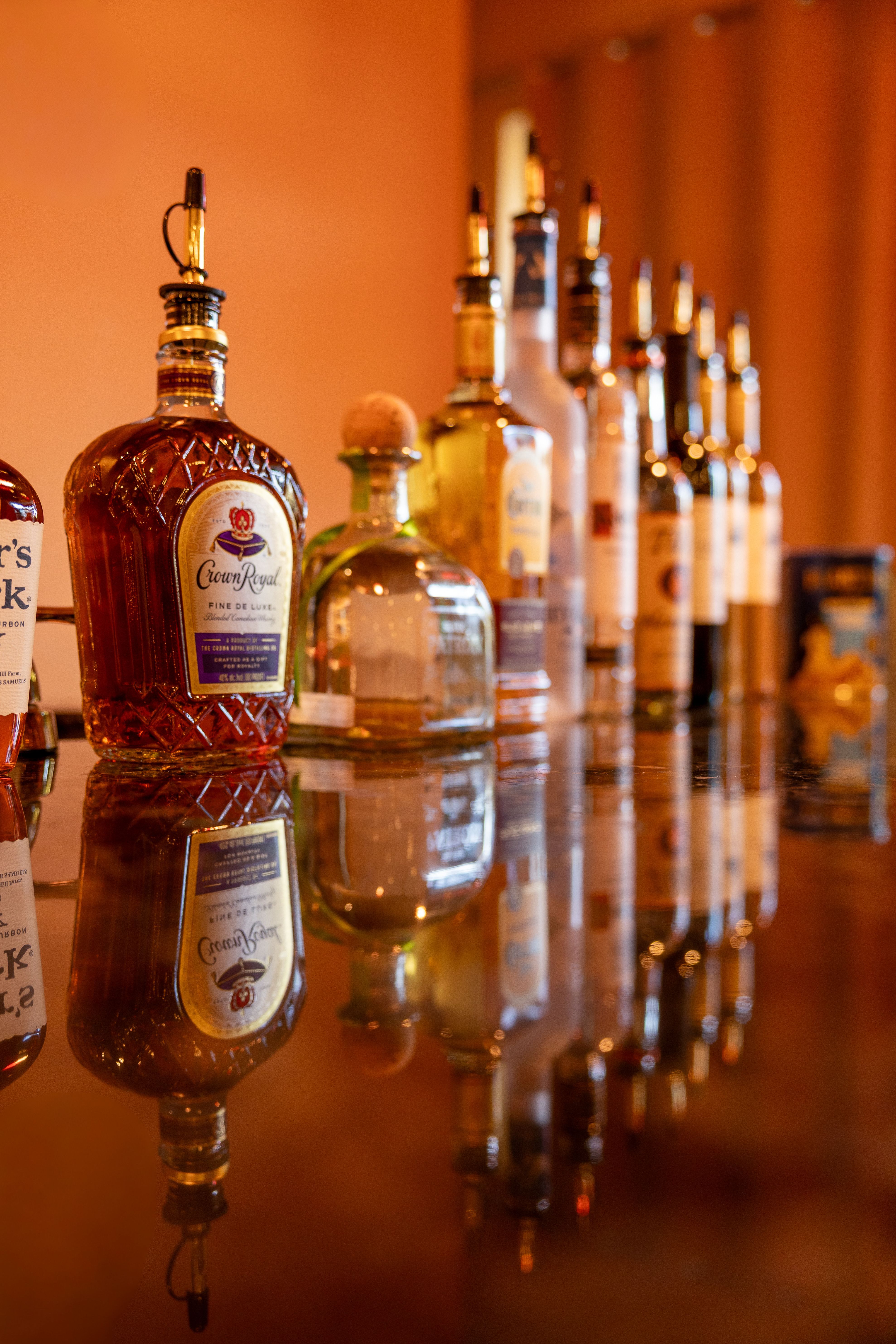 Assorted Premium Spirits on Reflective Bar · Free Stock Photo