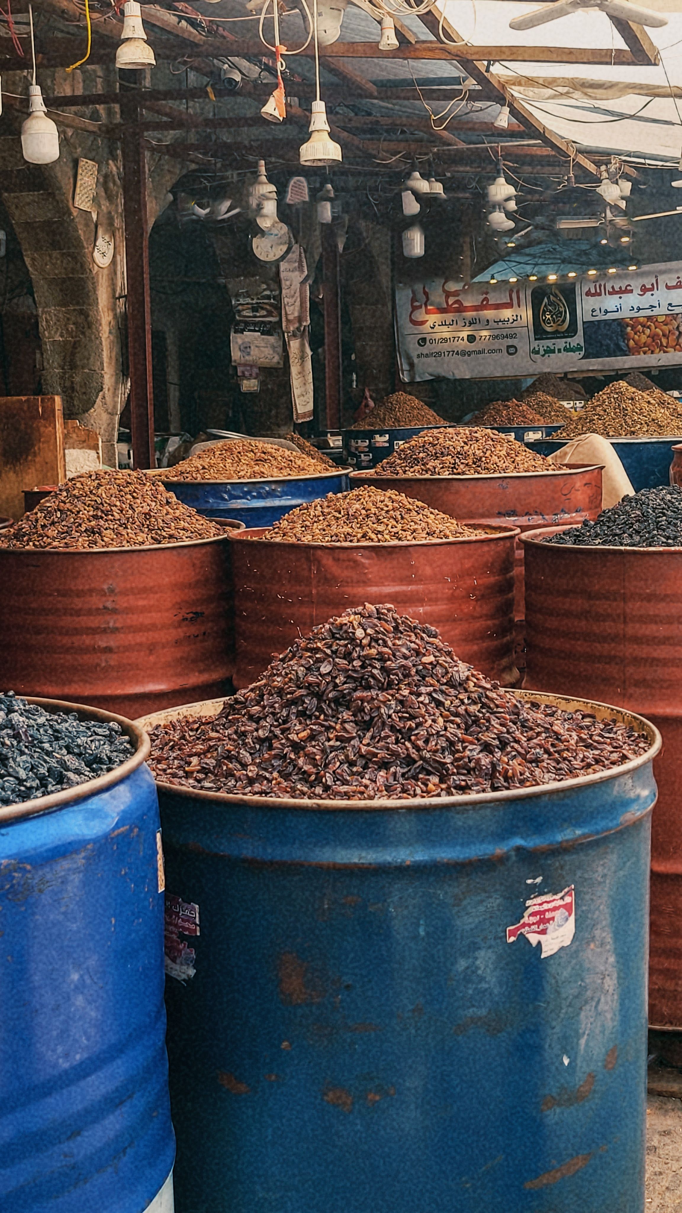 Vibrant Spice Market with Colorful Barrels · Free Stock Photo