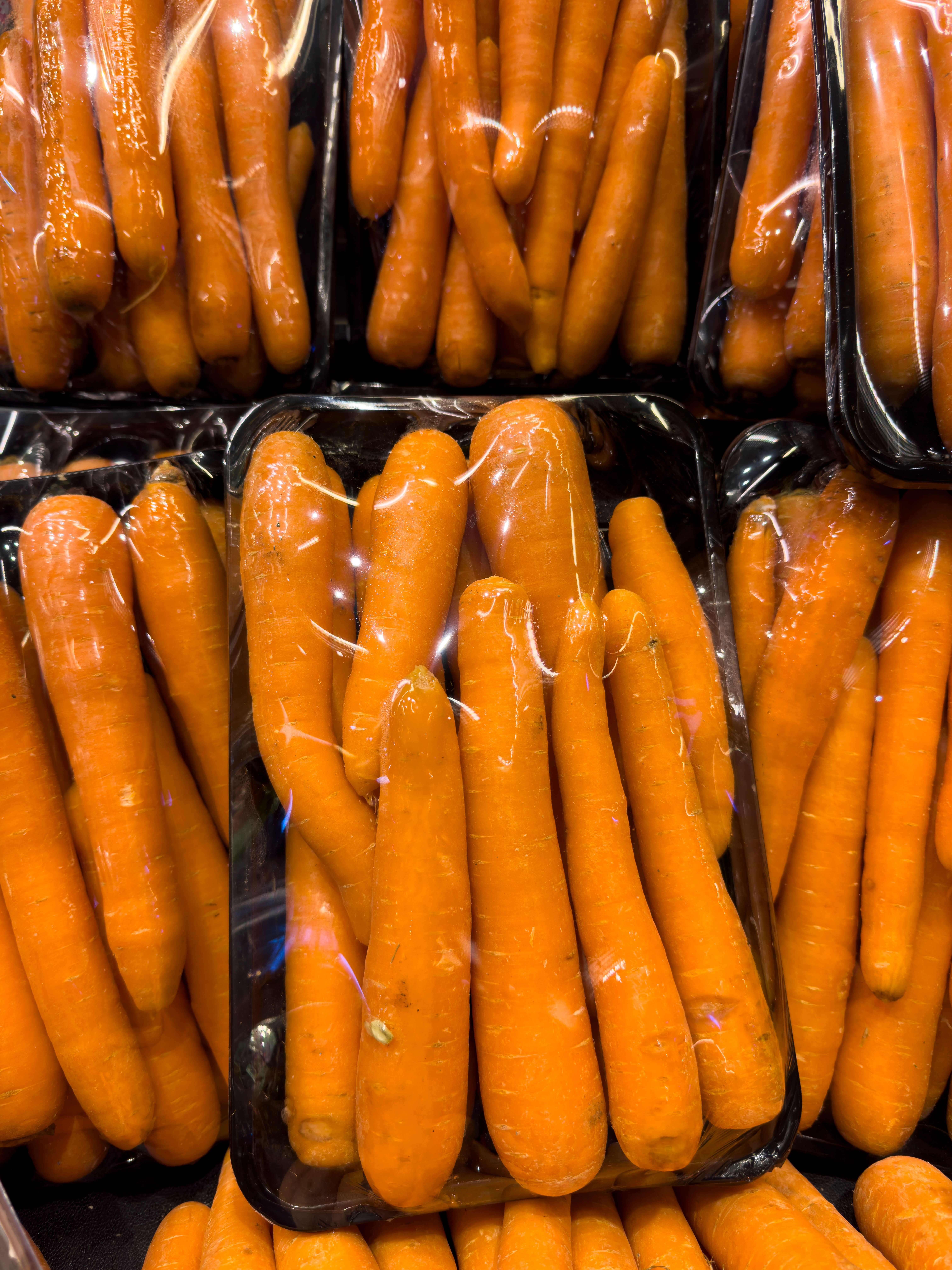 Fresh Packaged Carrots at Market Display · Free Stock Photo
