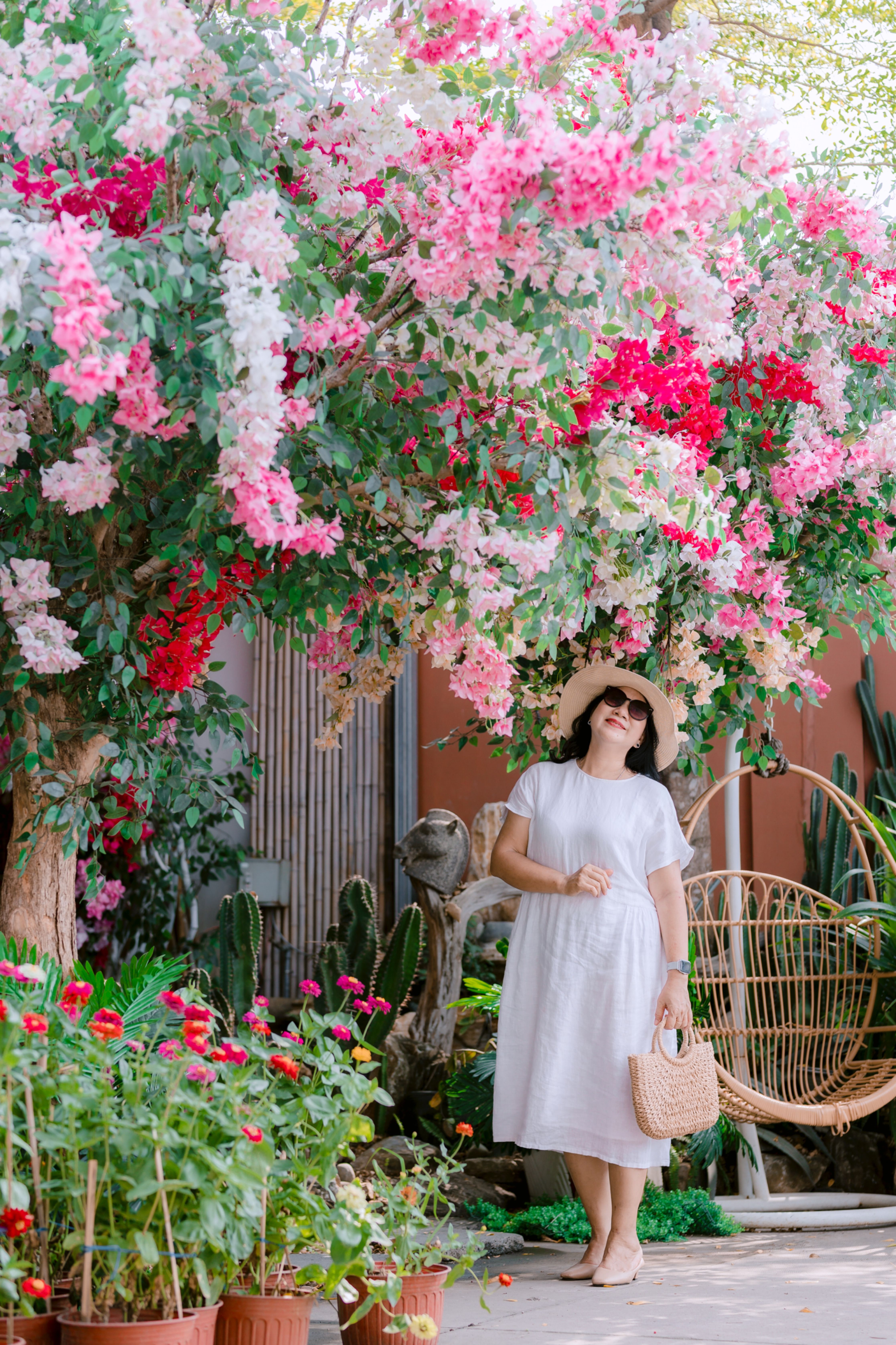 Woman in White Dress Under Vibrant Floral Tree · Free Stock Photo
