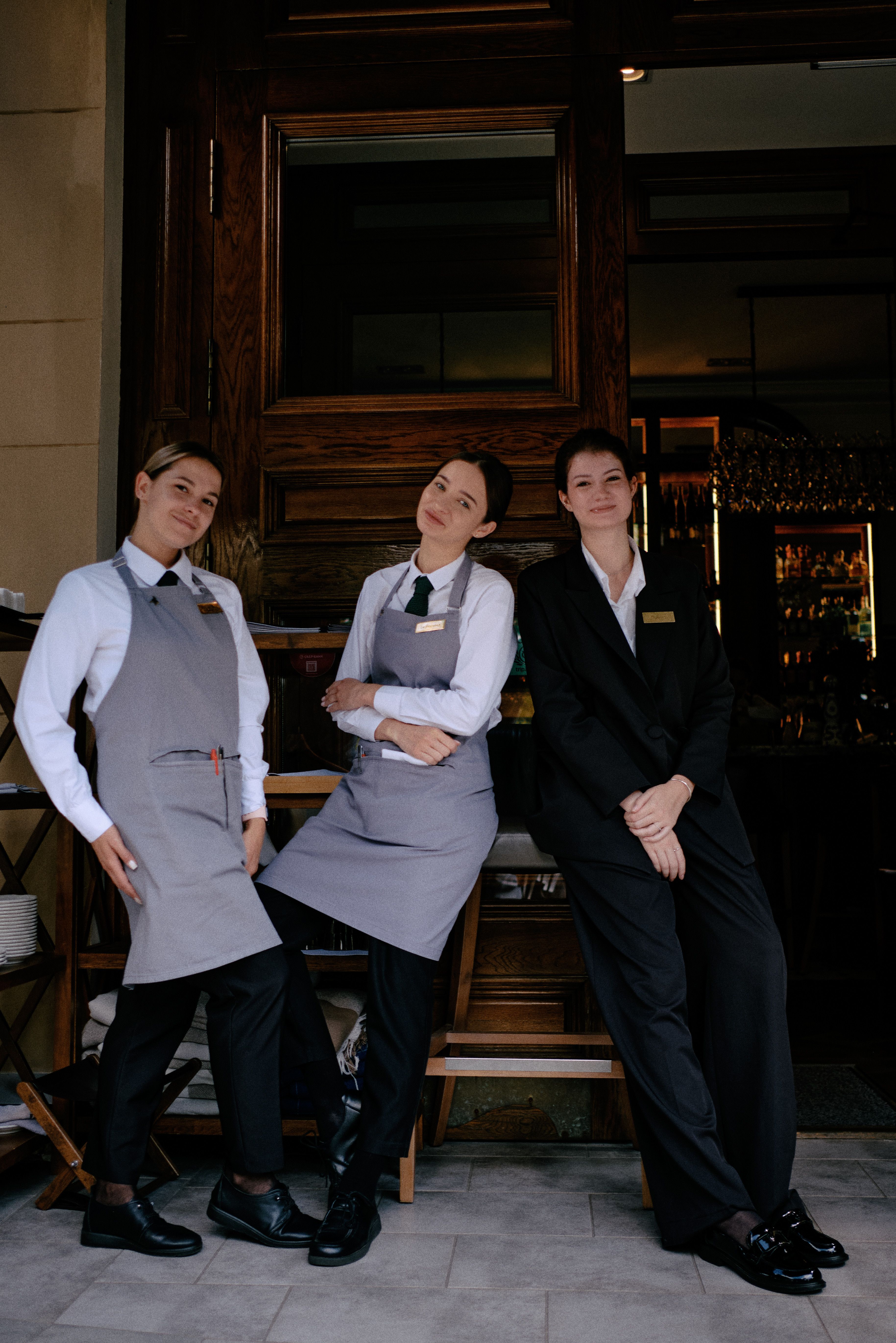 Restaurant Staff Posing in Uniforms Outdoors · Free Stock Photo