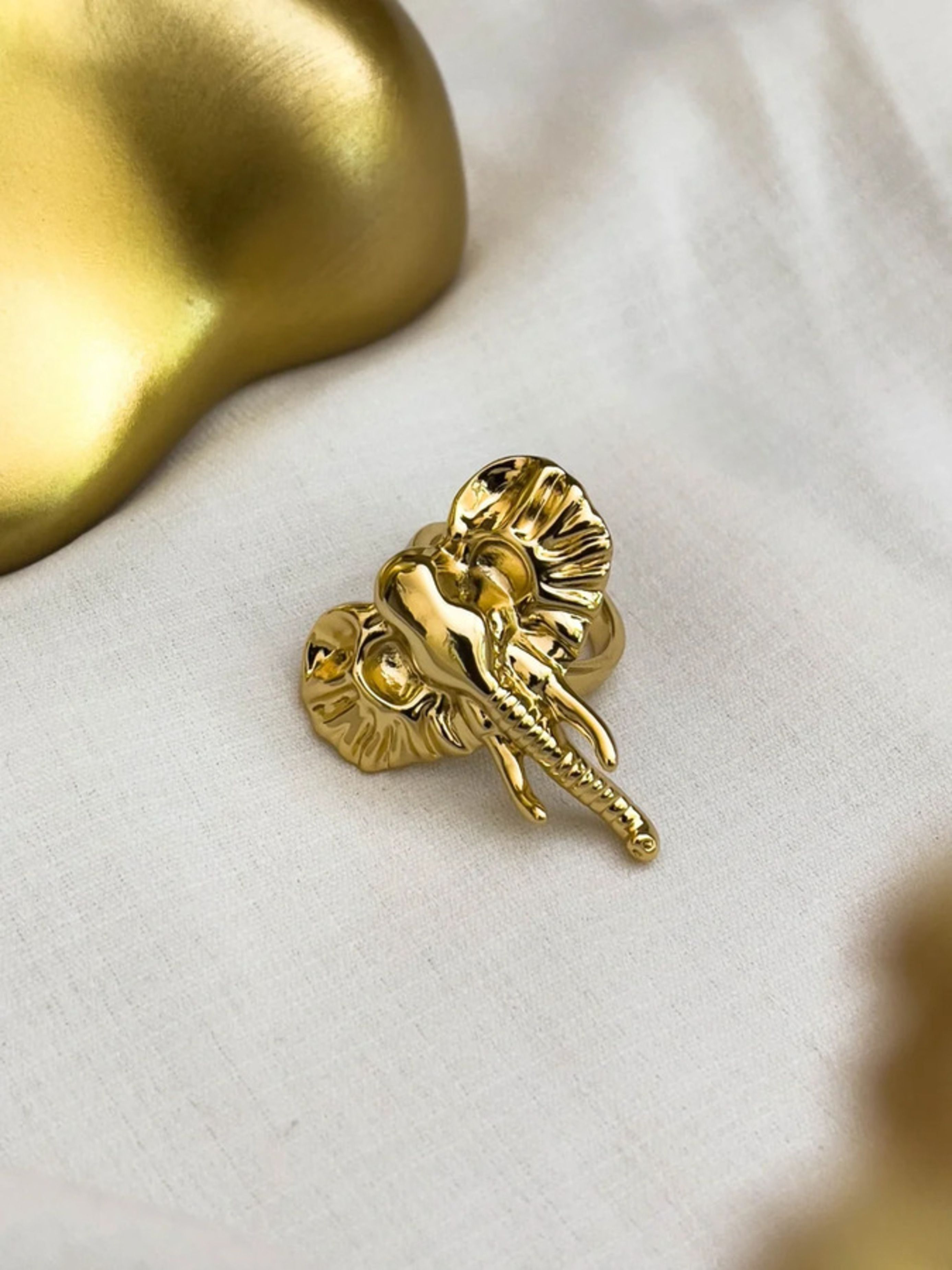 Gold Elephant Design Ring on White Fabric · Free Stock Photo