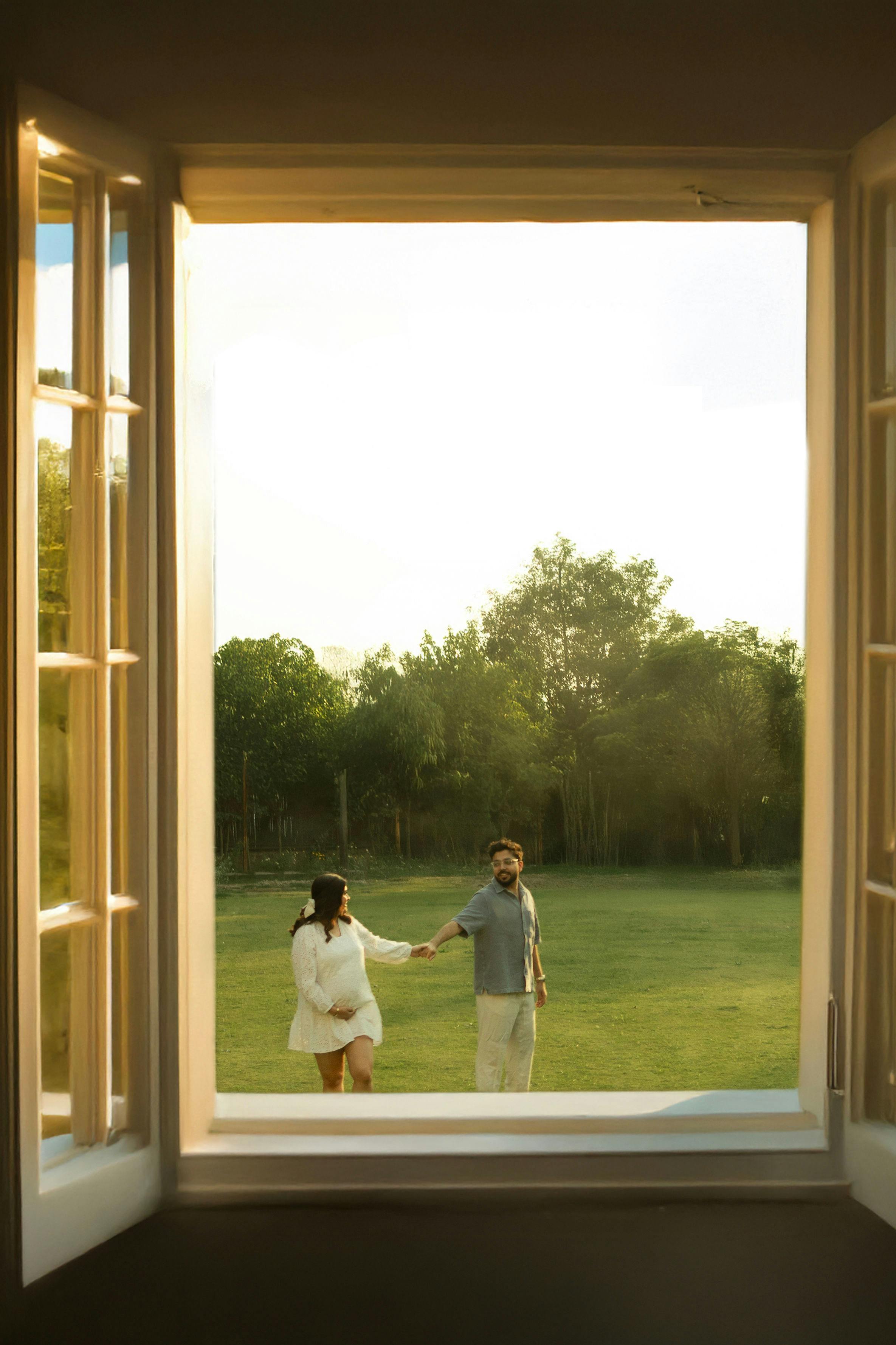 Outdoor Maternity Photo Shoot Through Window Frame · Free Stock Photo