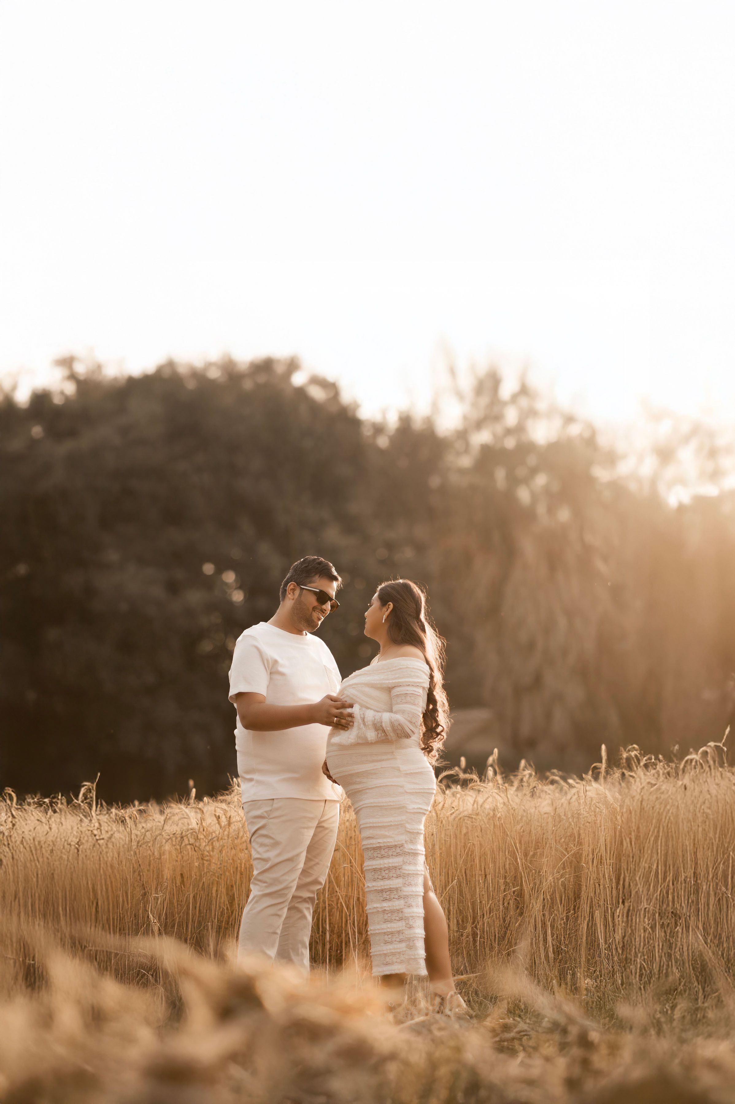 Romantic Maternity Photoshoot in Sunlit Field · Free Stock Photo