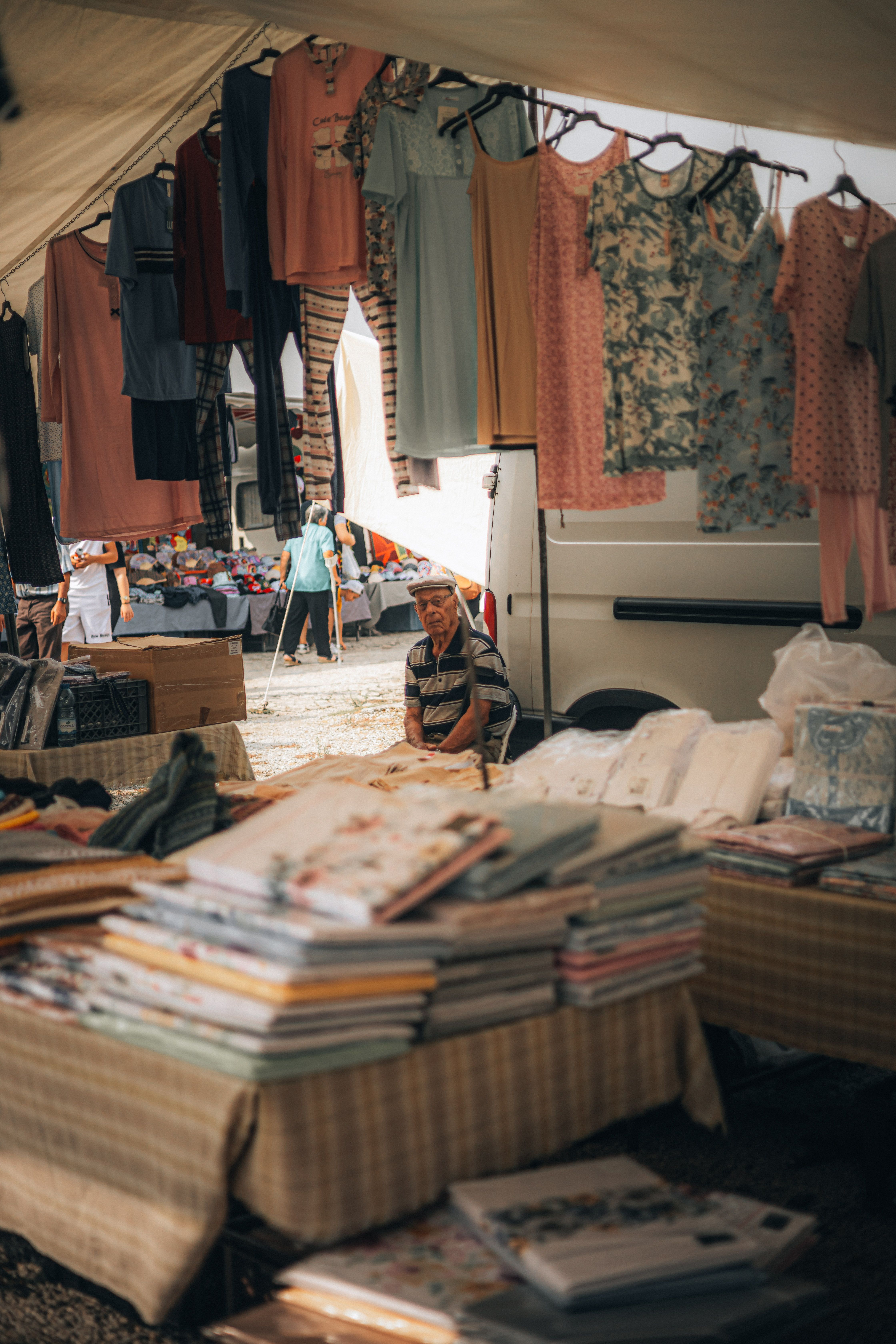 Vibrant Market Stall with Clothing and Textiles · Free Stock Photo